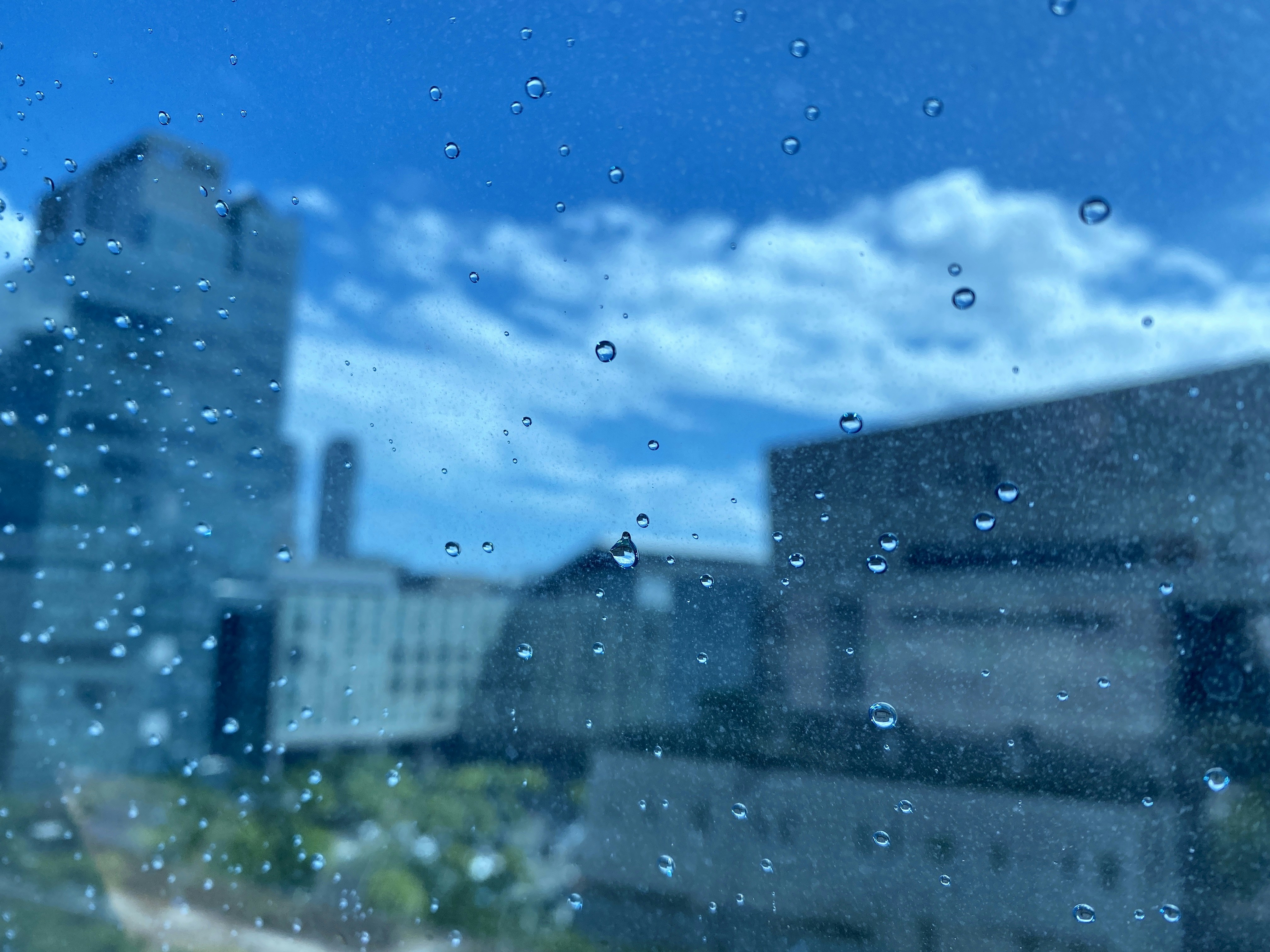 Rain-Dusted Glass Over a Blue-Tinted Cityscape