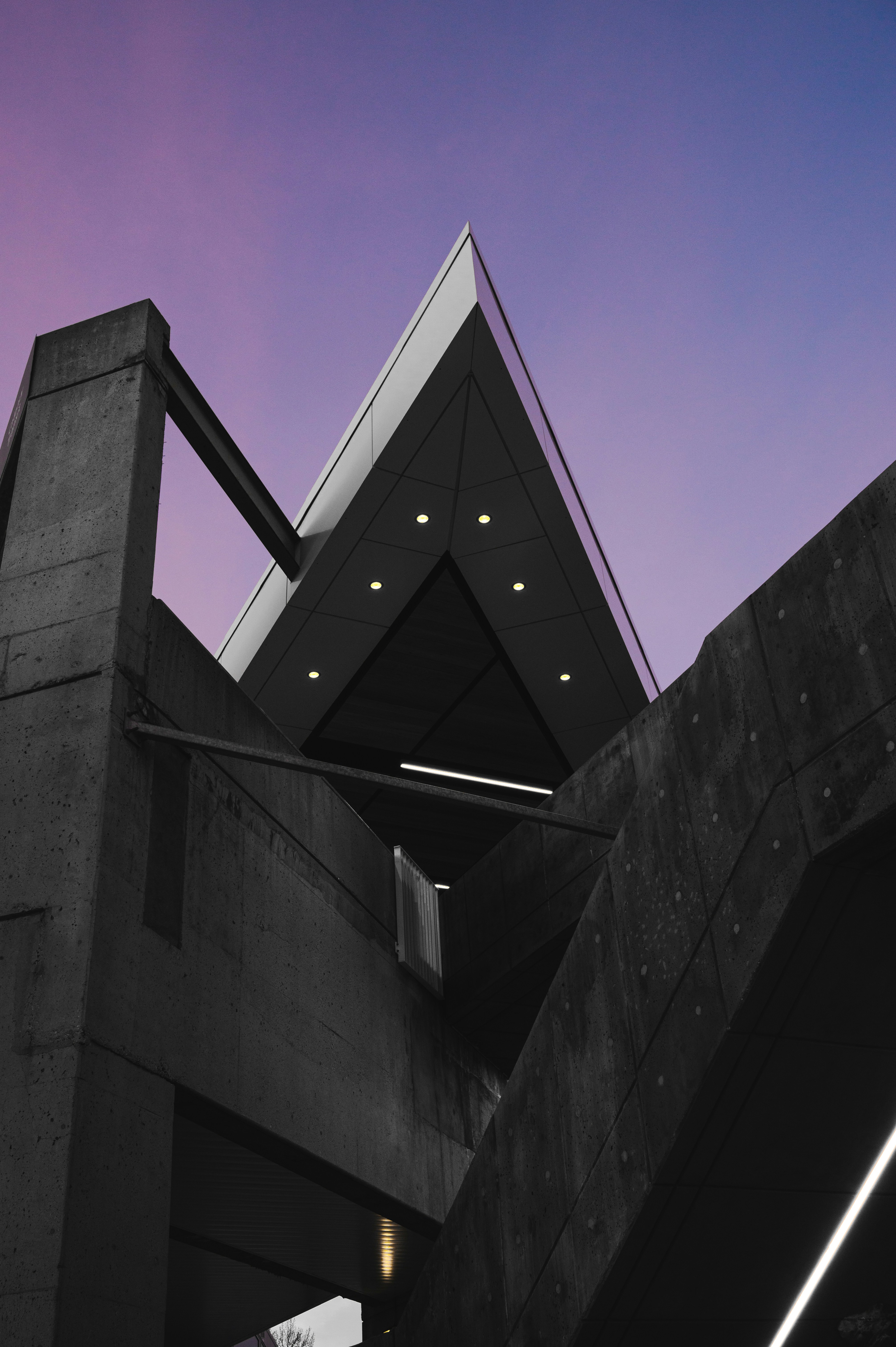 Piercing Angle: Concrete Geometry Against a Purple Sky
