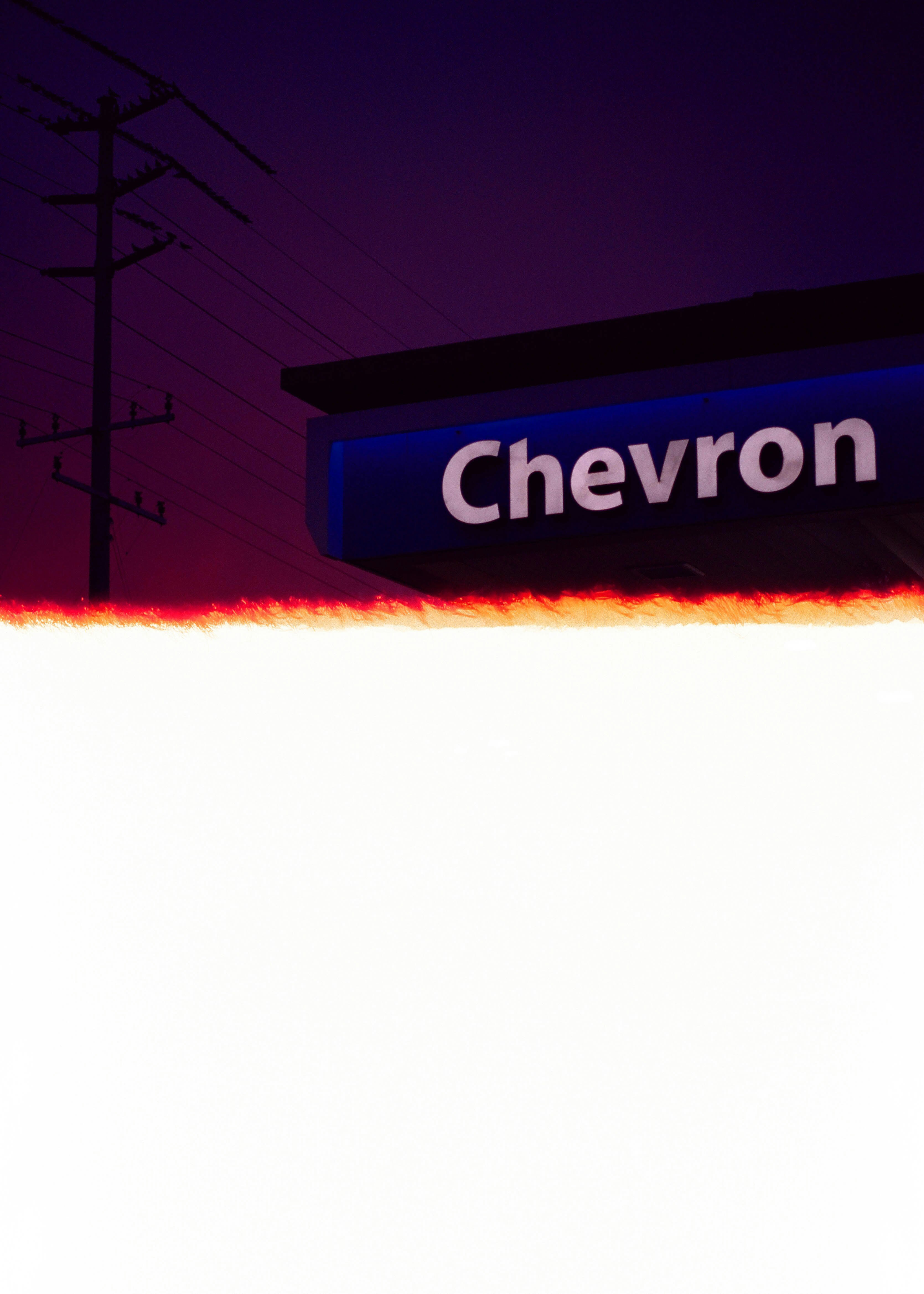 A chevron gas station sign at night photo – Free California Image on ...