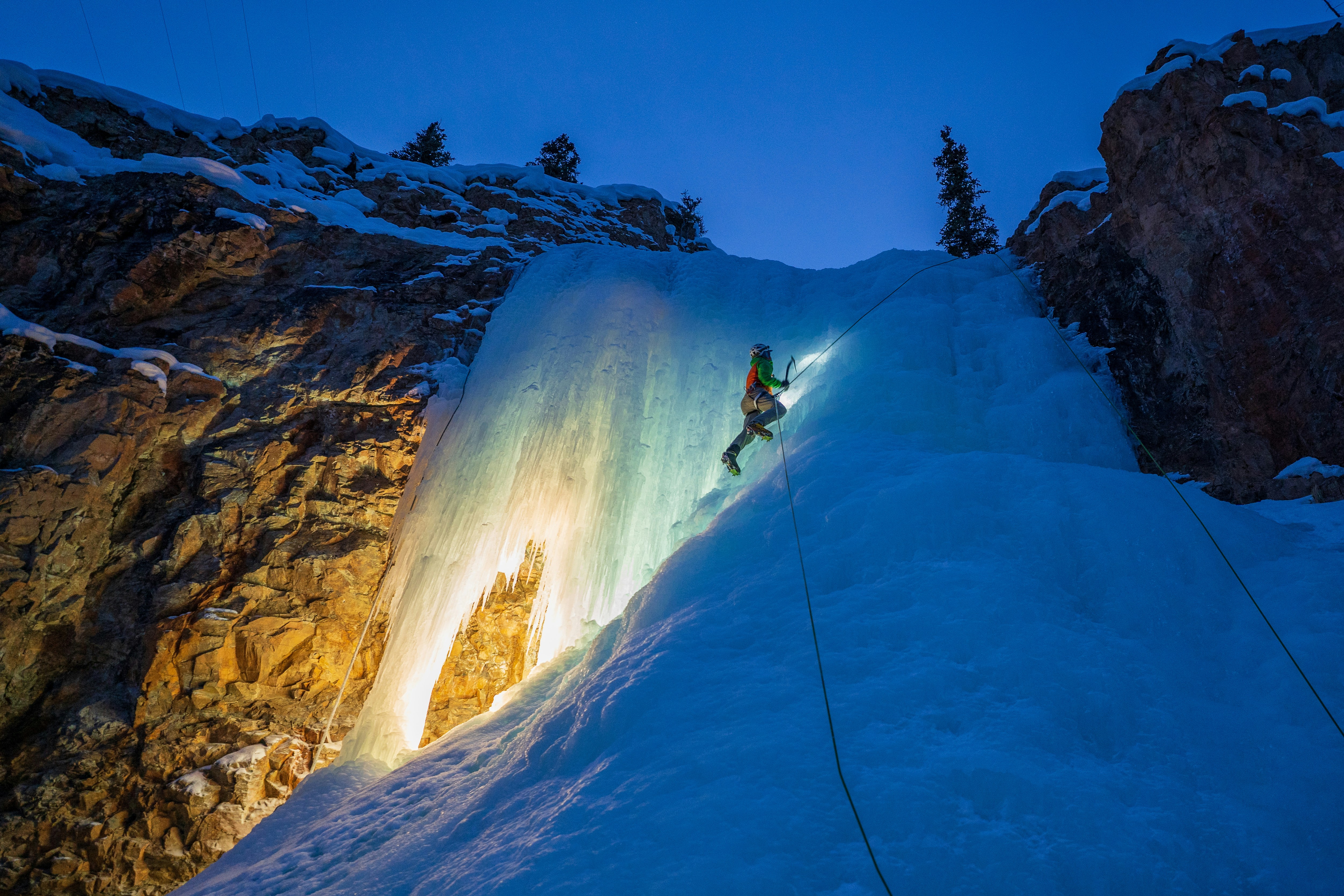 Blue Hour Ascents: Climber on a Luminous Icefall