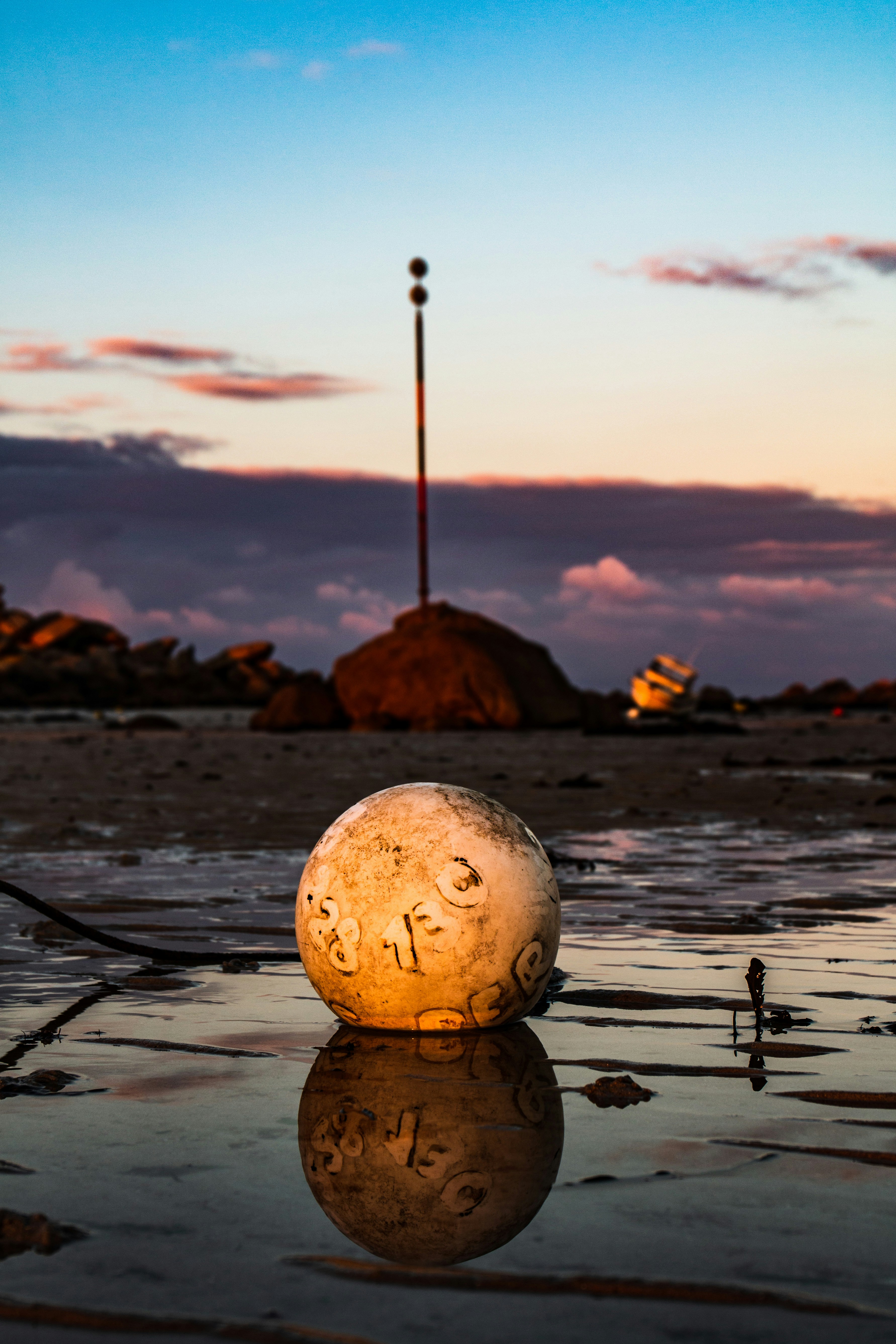 Ball on the Shoreline: Echoes of Sunset and Foam