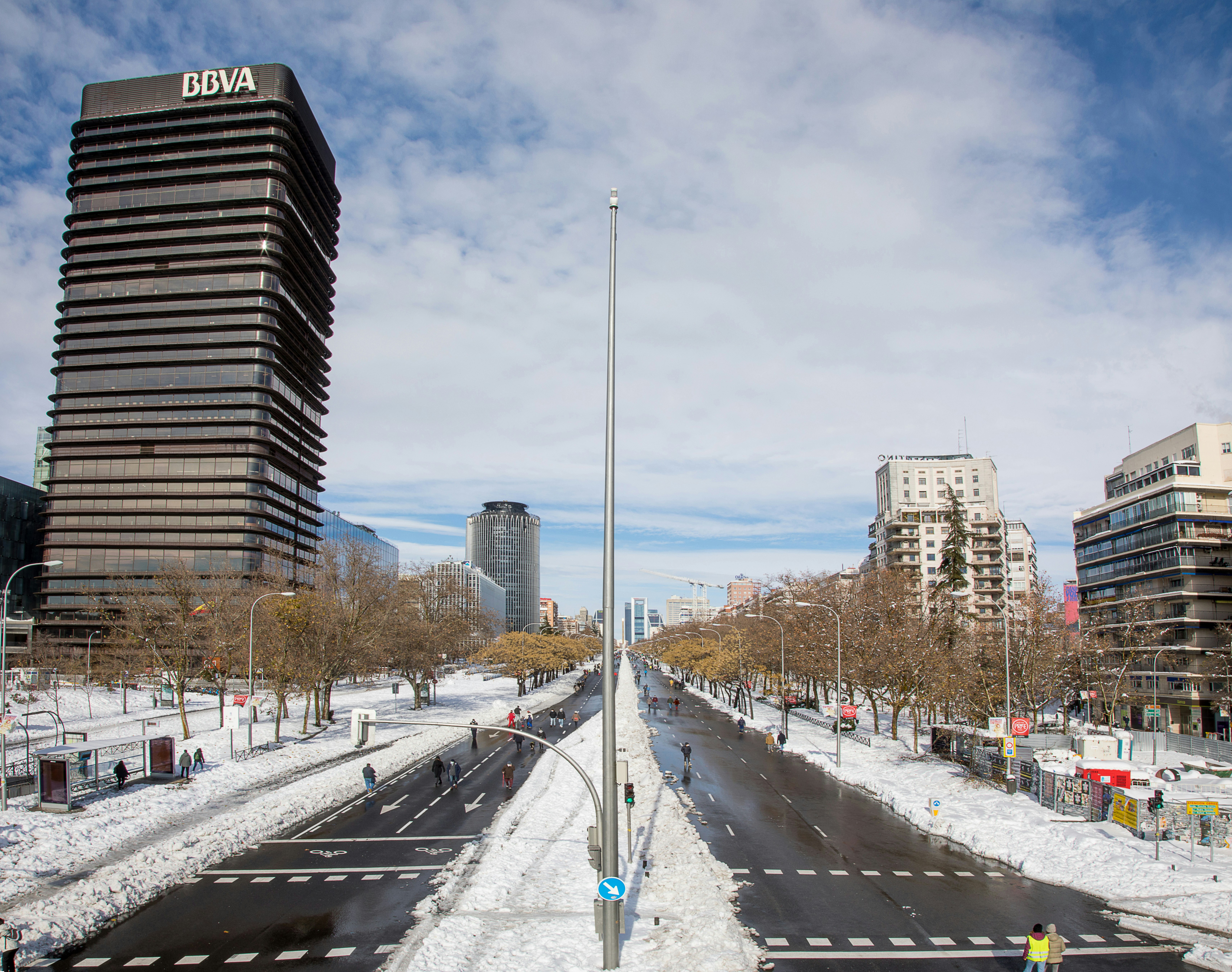 cars on road near city buildings during daytime