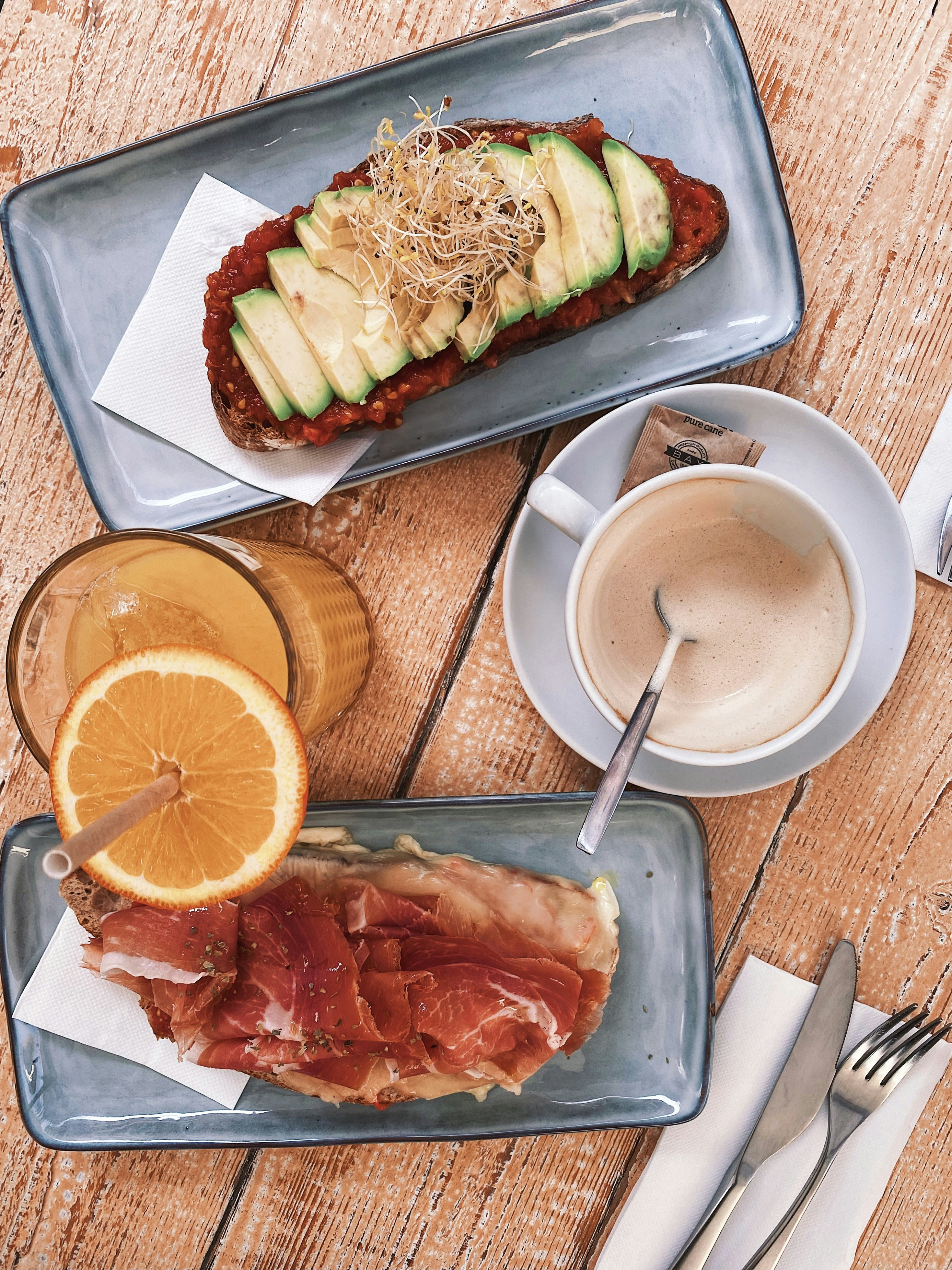 Sliced of raw meat on rectangular white ceramic plate beside stainless ...