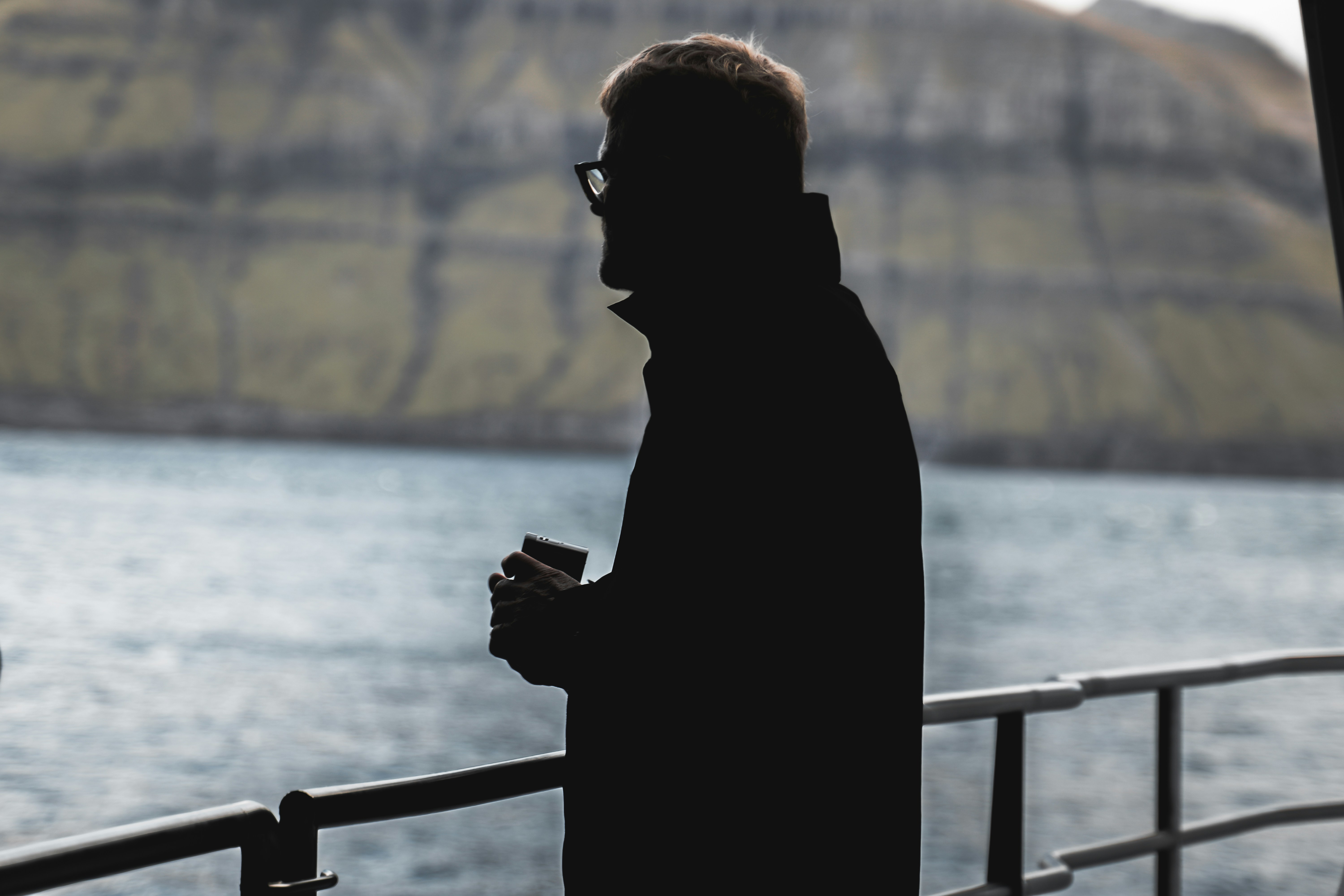 Silhouette on the Pier: Contemplation by the Water