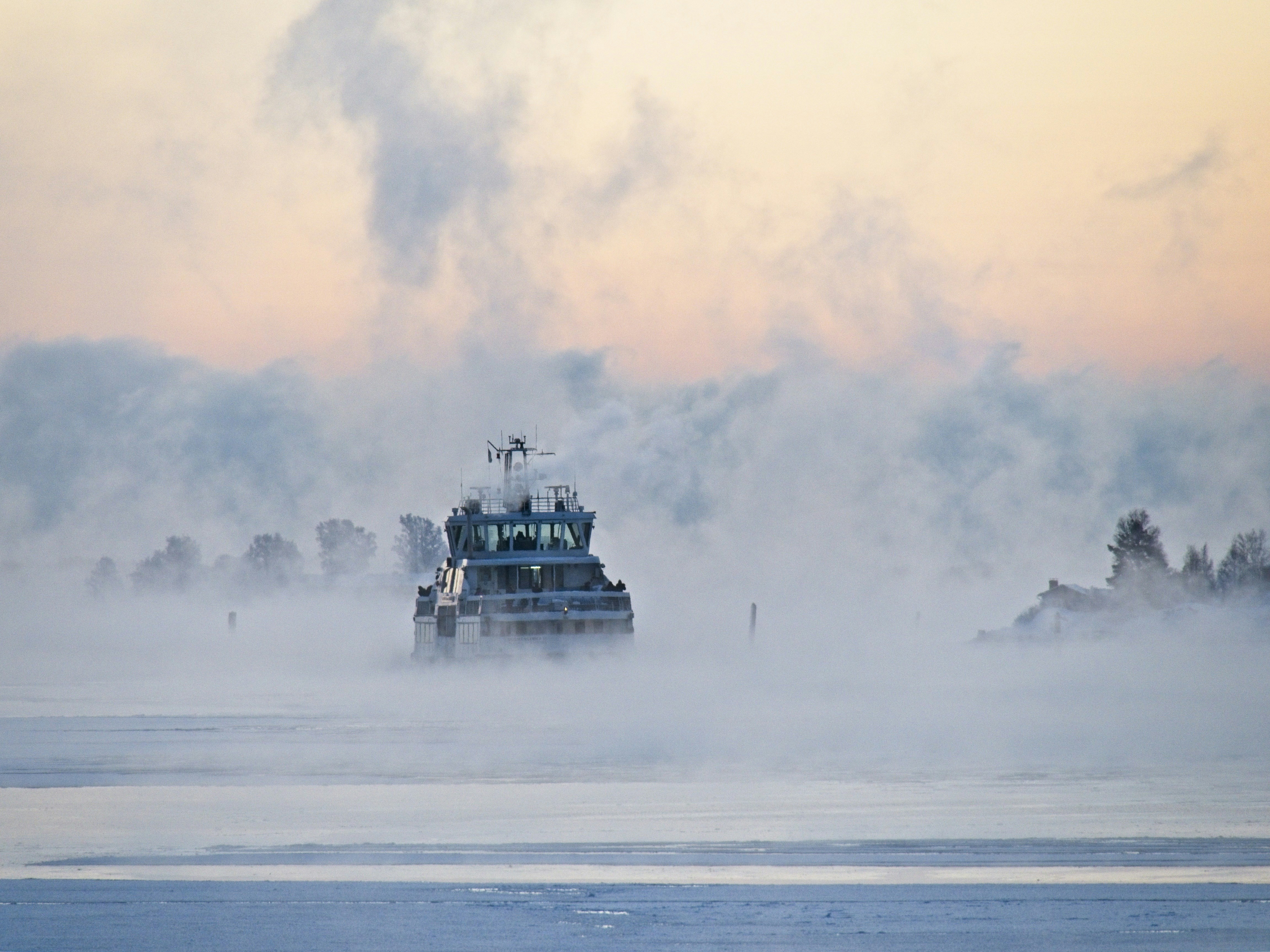 Mist-veiled Tug Emerging Through Dawn on a Glassy River