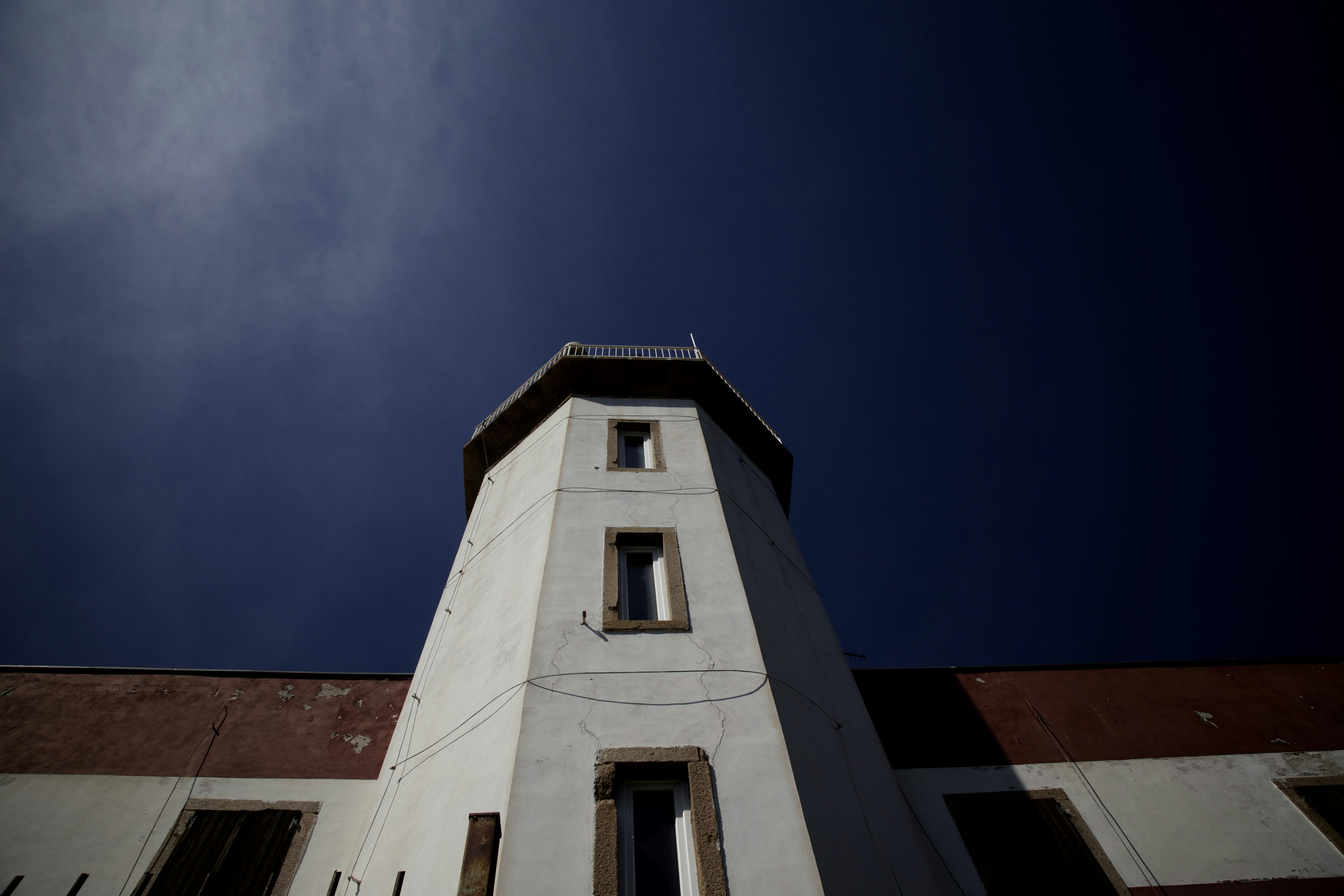 Skyward Facade: A White Tower Reaching Toward a Velvet Night