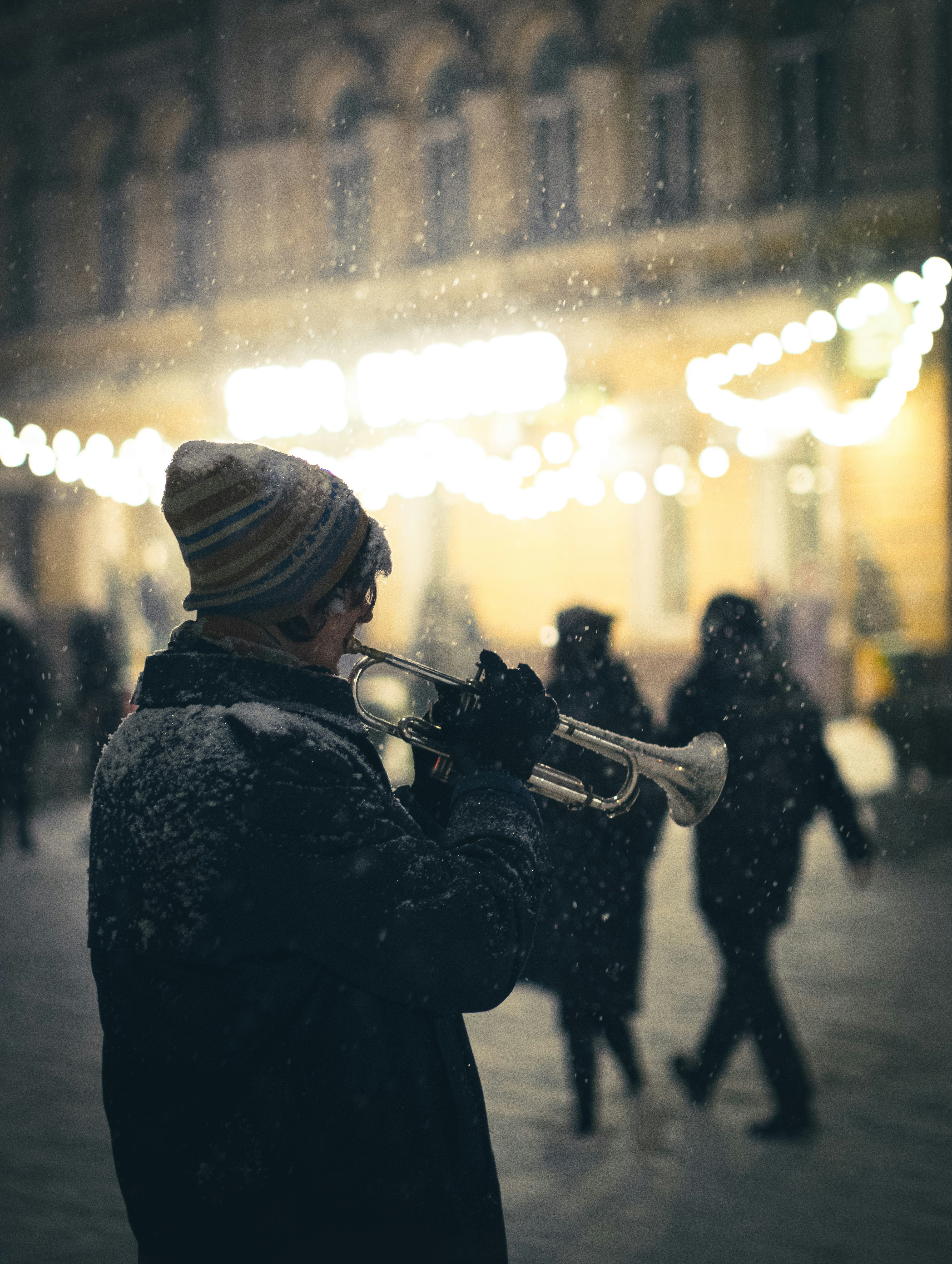 Winter Jazz in the Snow: A Trumpet Player Framed by Golden City Lights