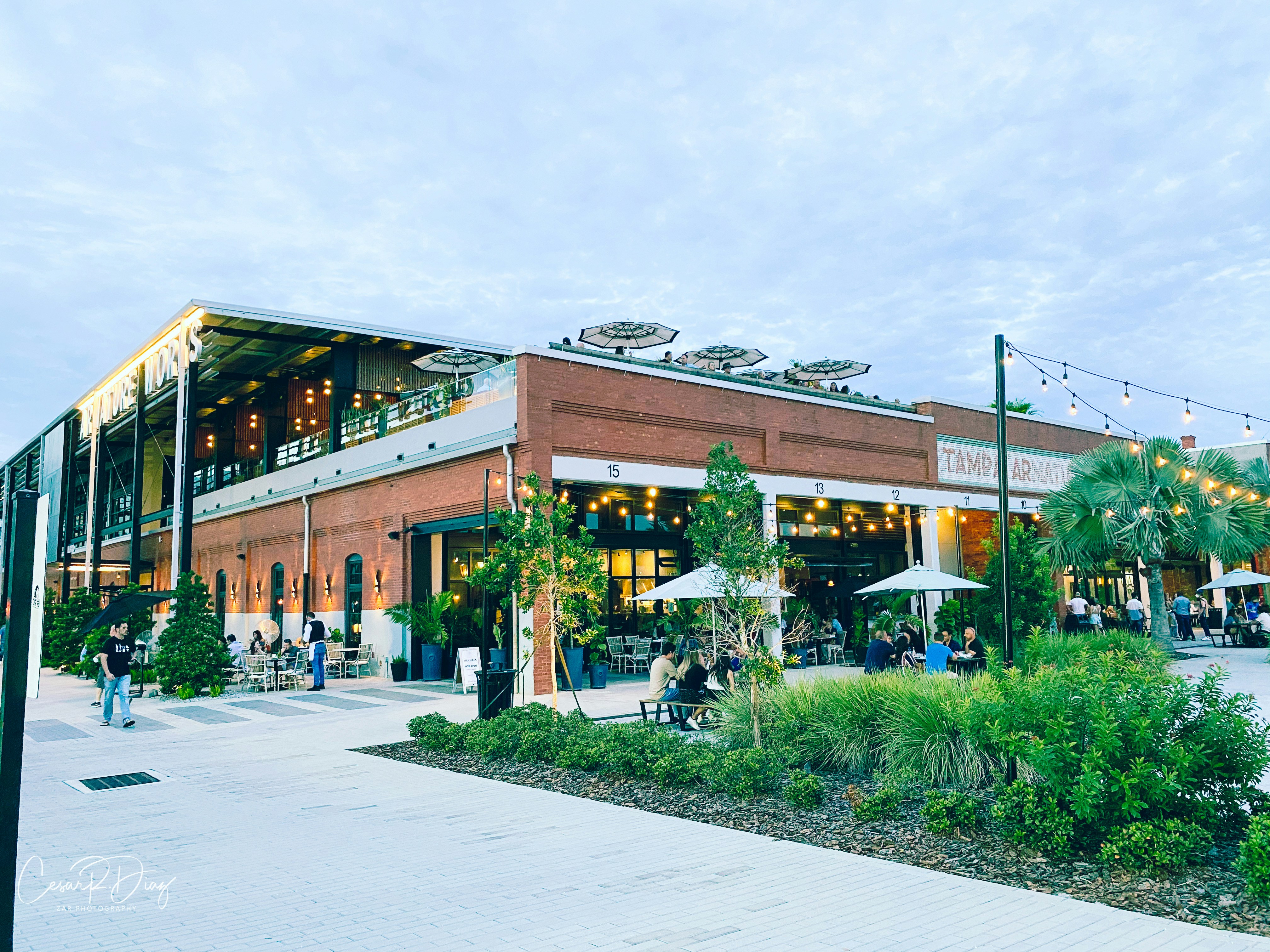people walking on sidewalk near brown building during daytime
