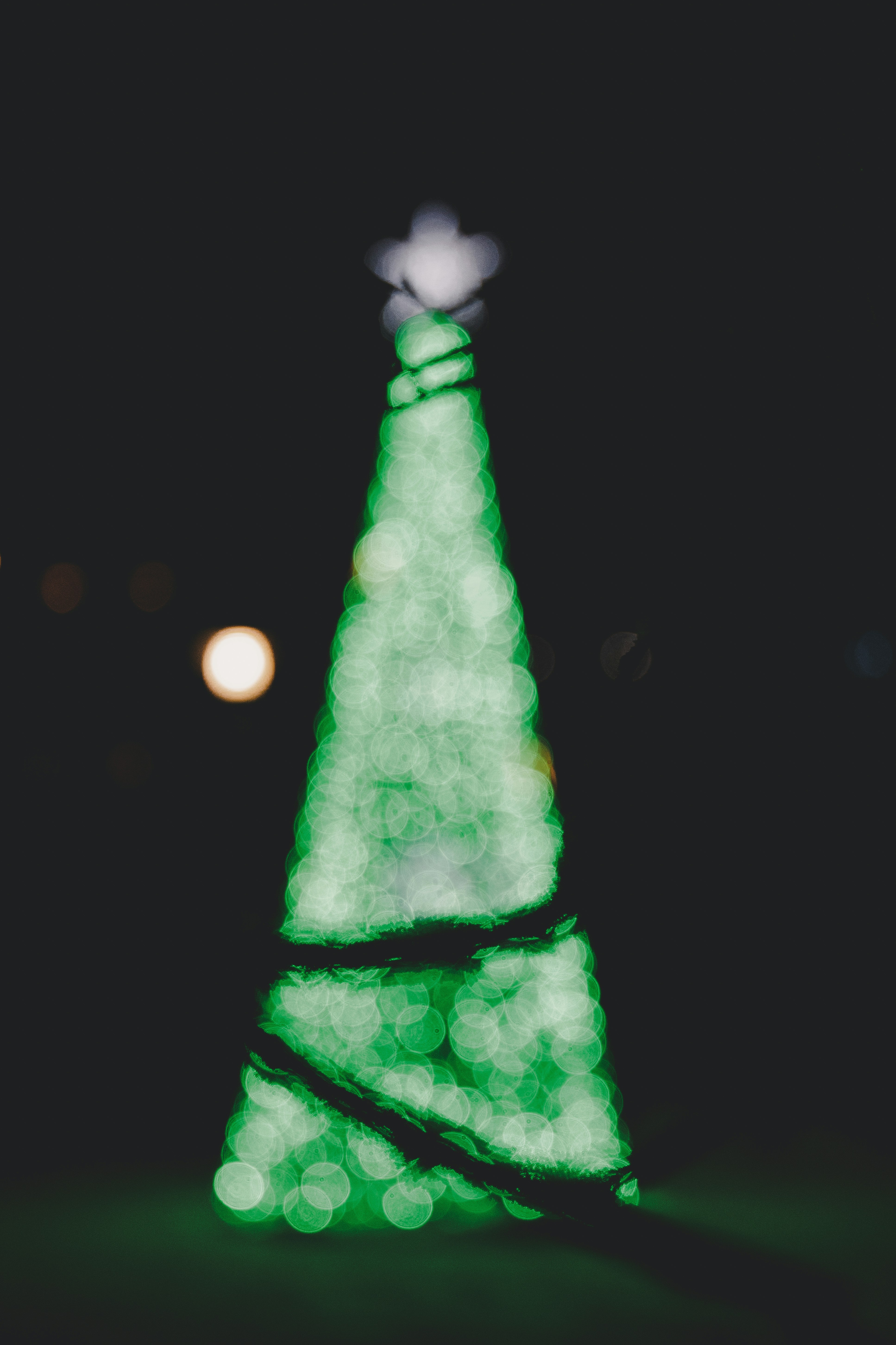 Emerald Spire in Velvet Night: A Quiet Bloom of Bokeh Lights