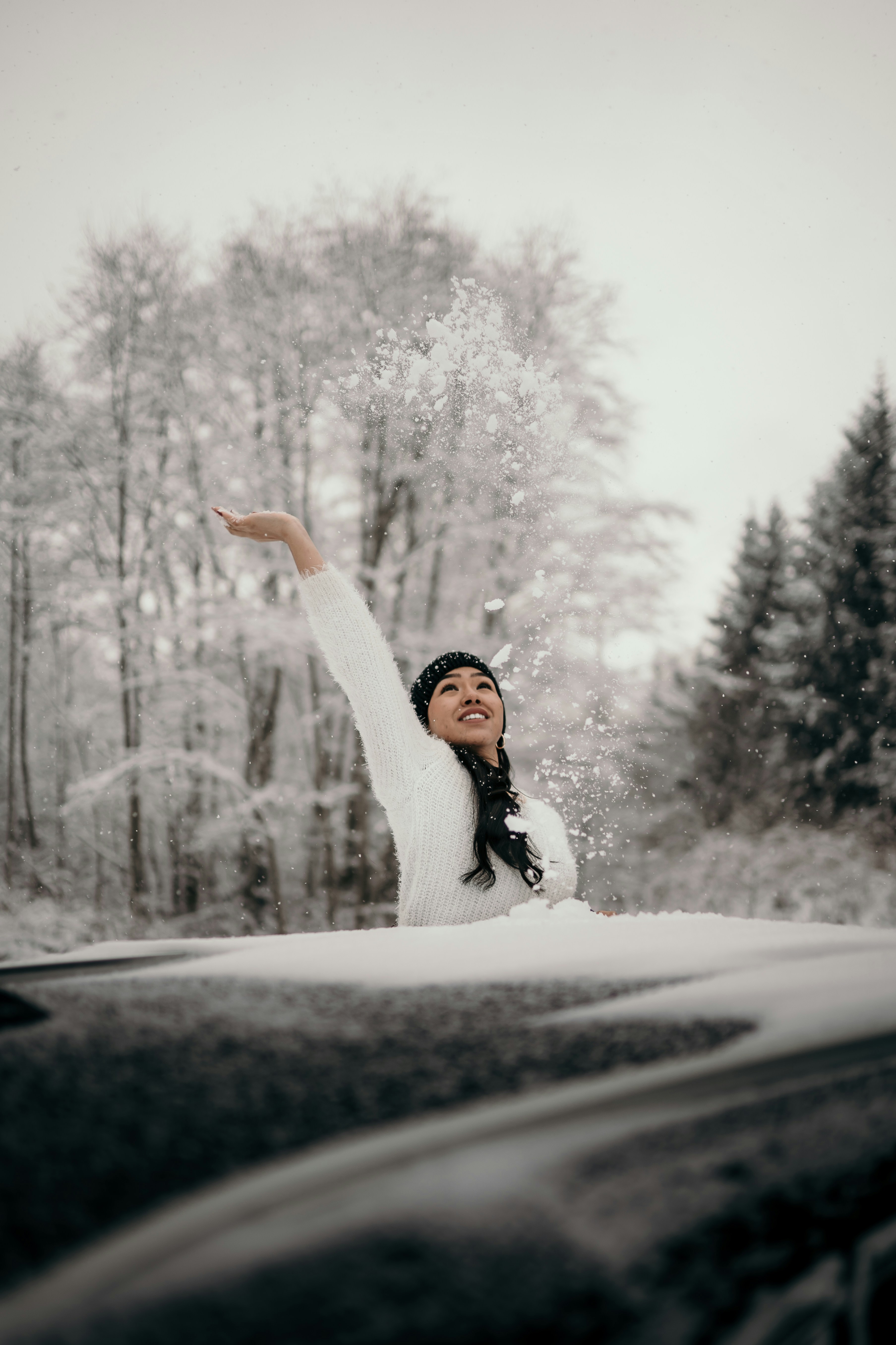 Snow Sprite: A Woman Tossing Winter Sparkles Amid Silent Pines