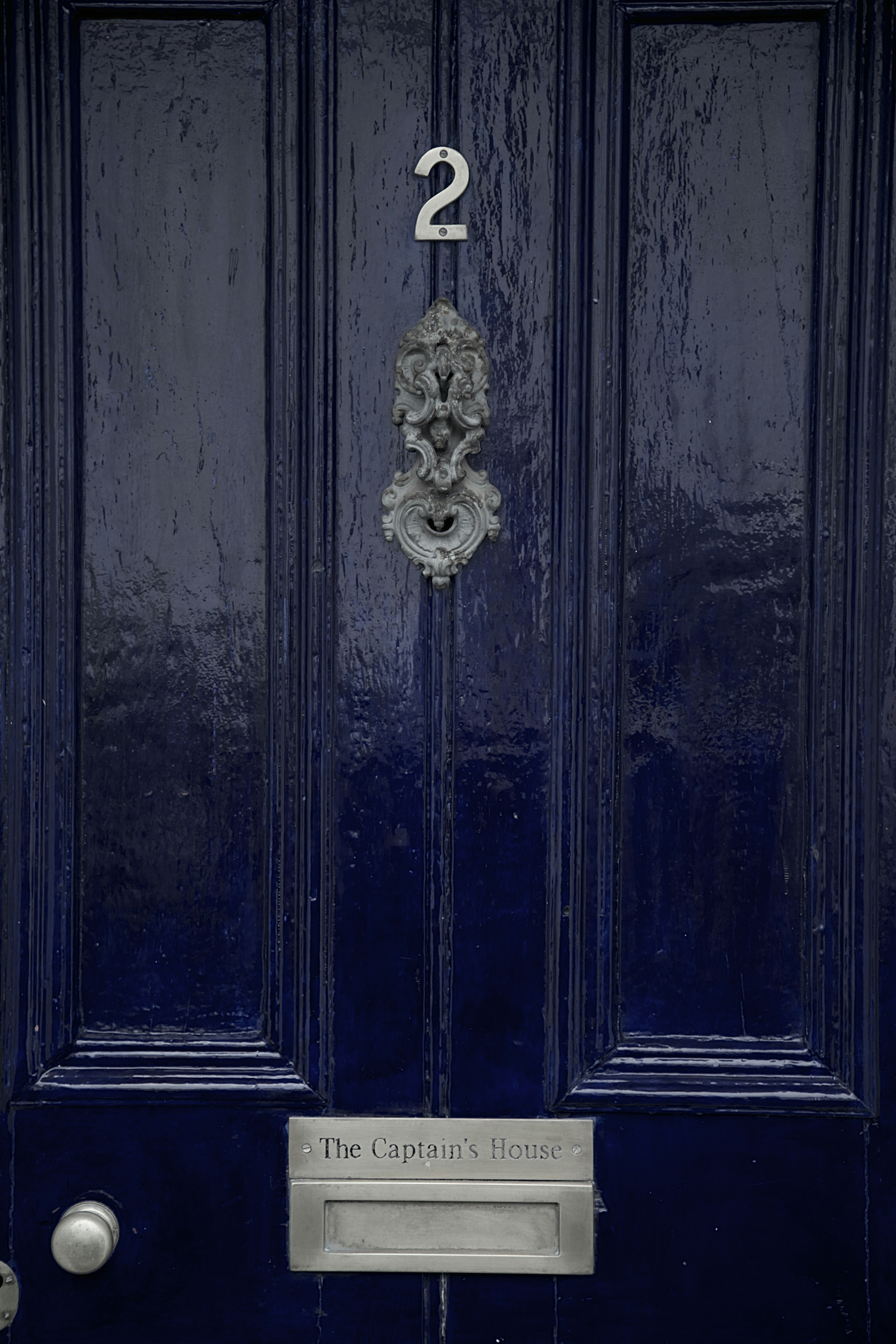 The Captain's House: An Ornate Knocker on a Midnight Navy Door