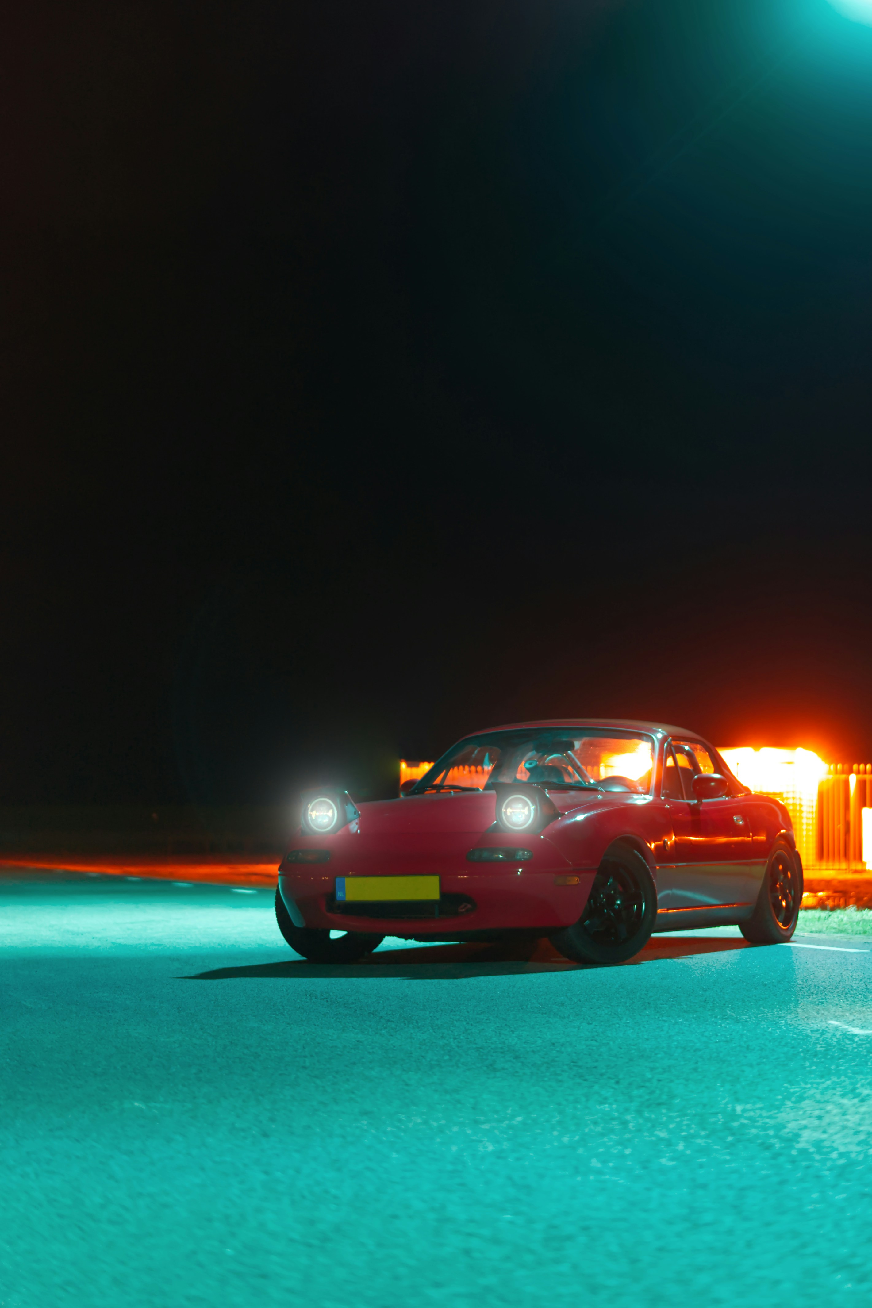 Neon Night Porsche: A Red Classic Basking in Cyan Street Glow