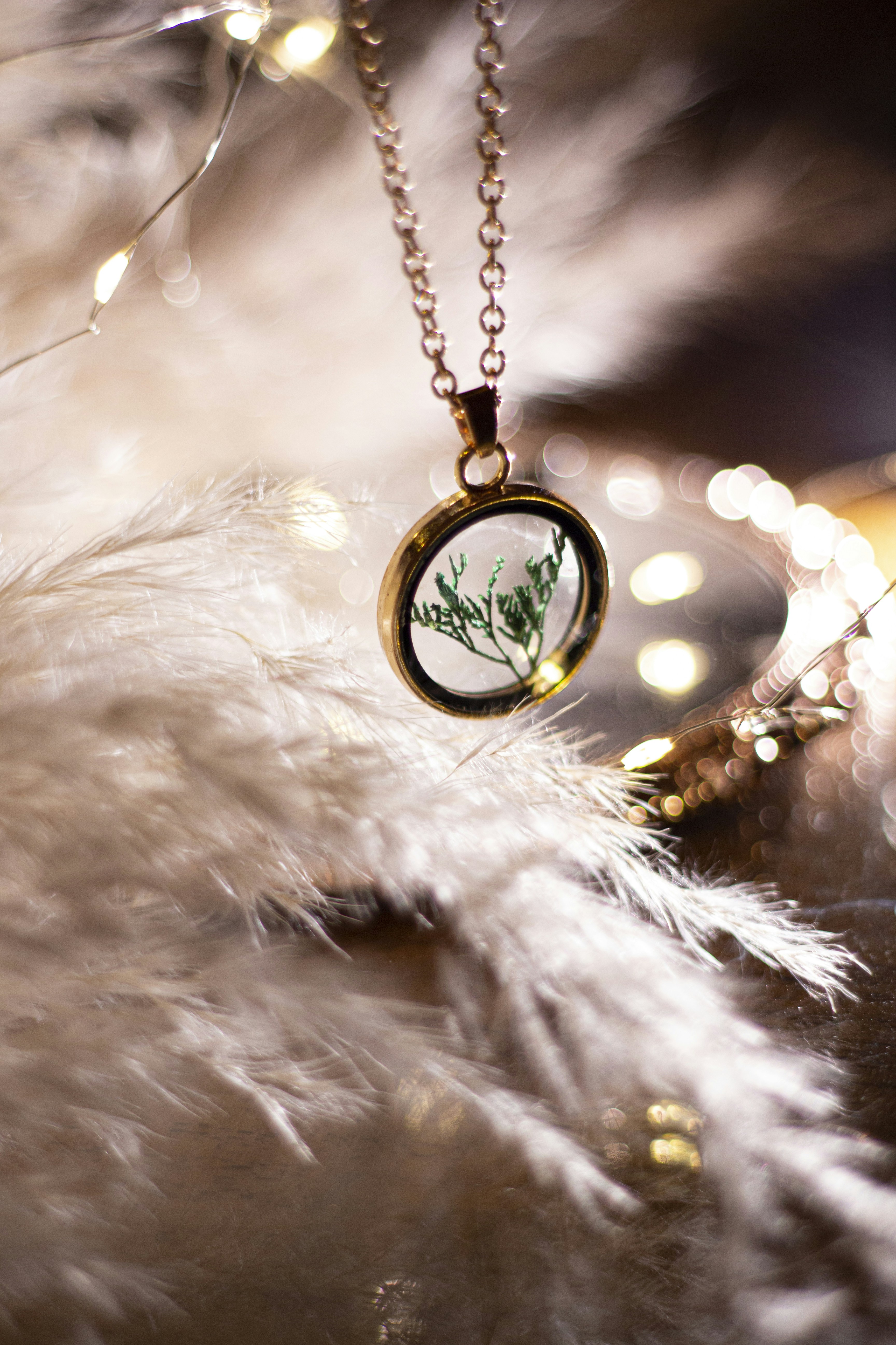Emerald fern in a golden pendant: a delicate holiday moment