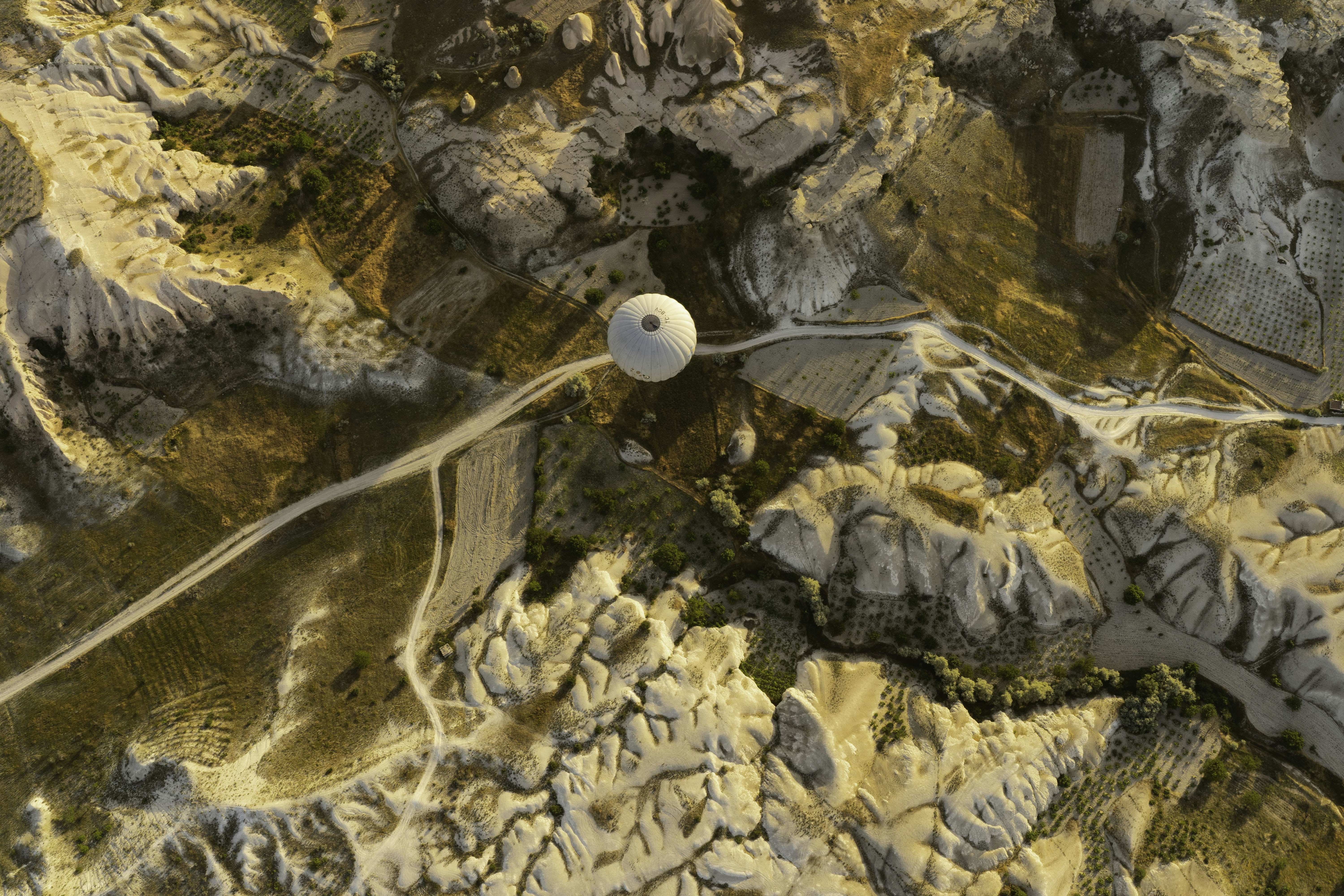white round ball on brown and gray rock formation