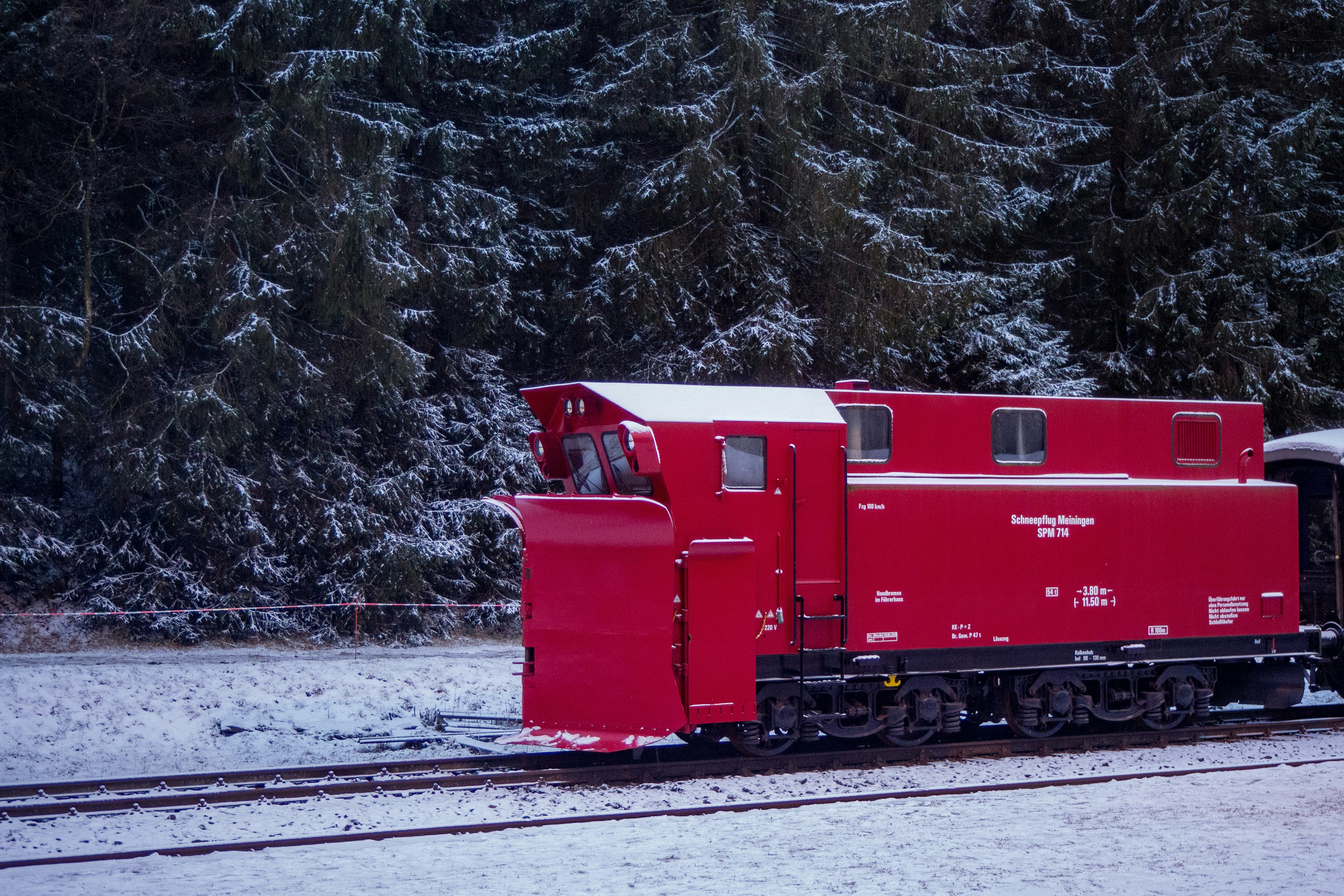 Red Hauler on Snow: a lone locomotive against a pine-dusted backdrop