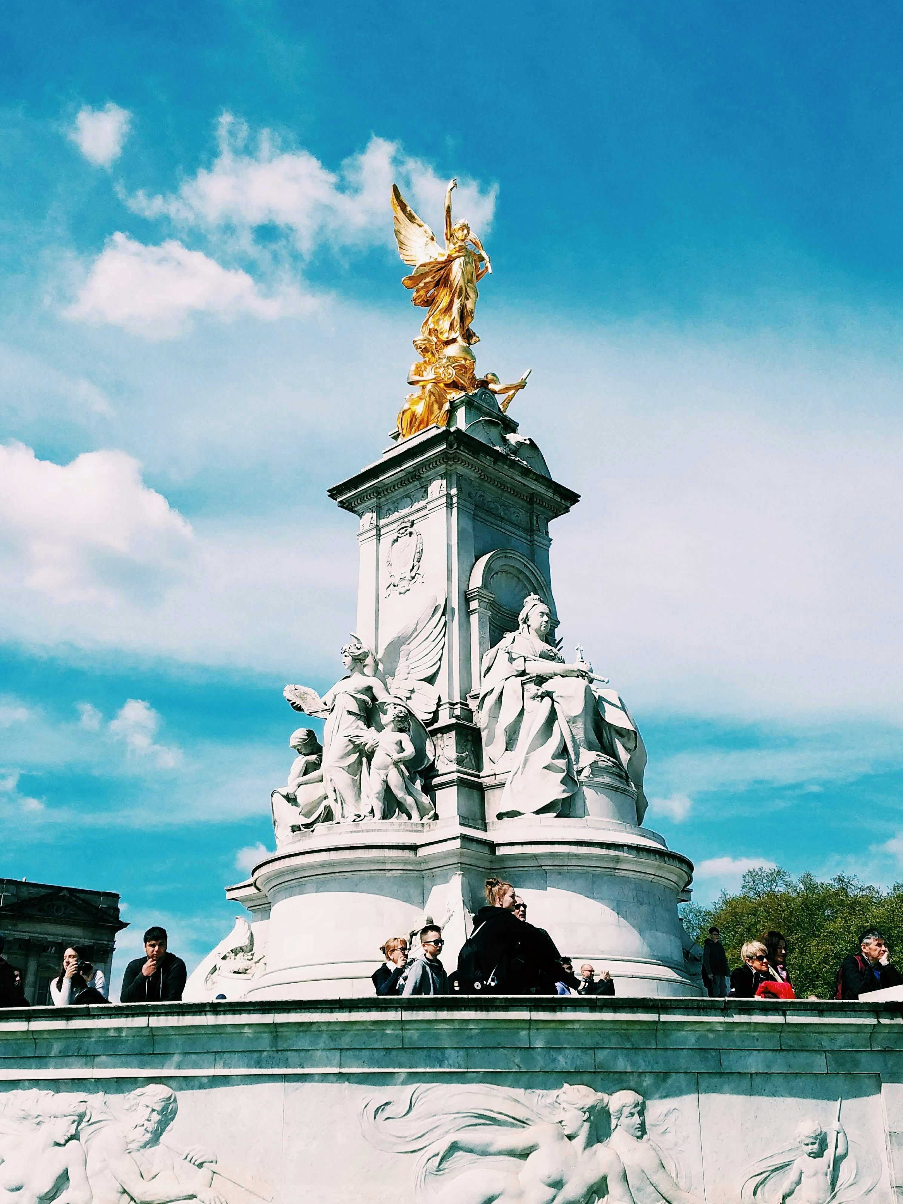 Gilded Apex: Winged Victory Above Marble Pedestal