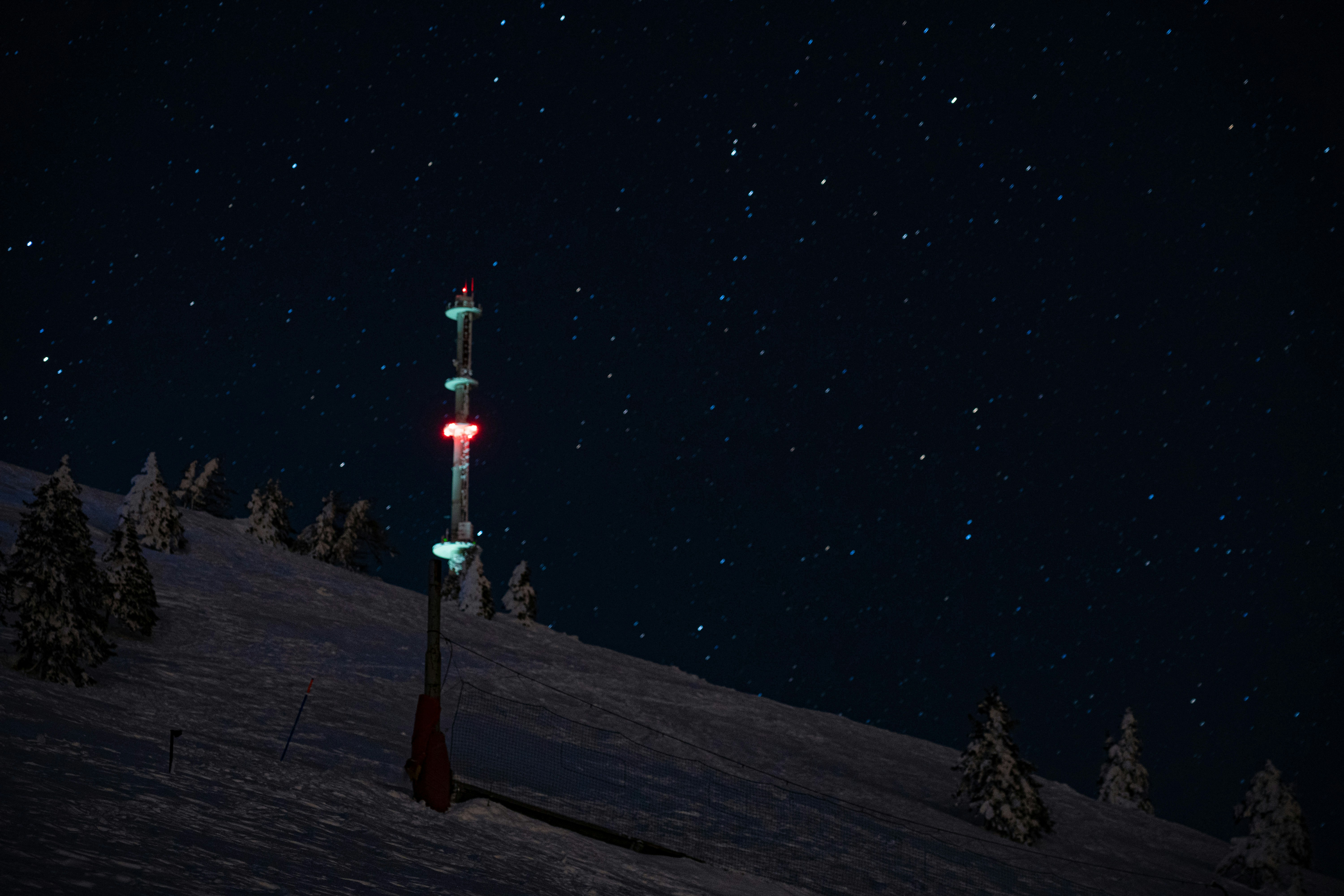 Red and white tower during night time photo – Free Black Image on Unsplash