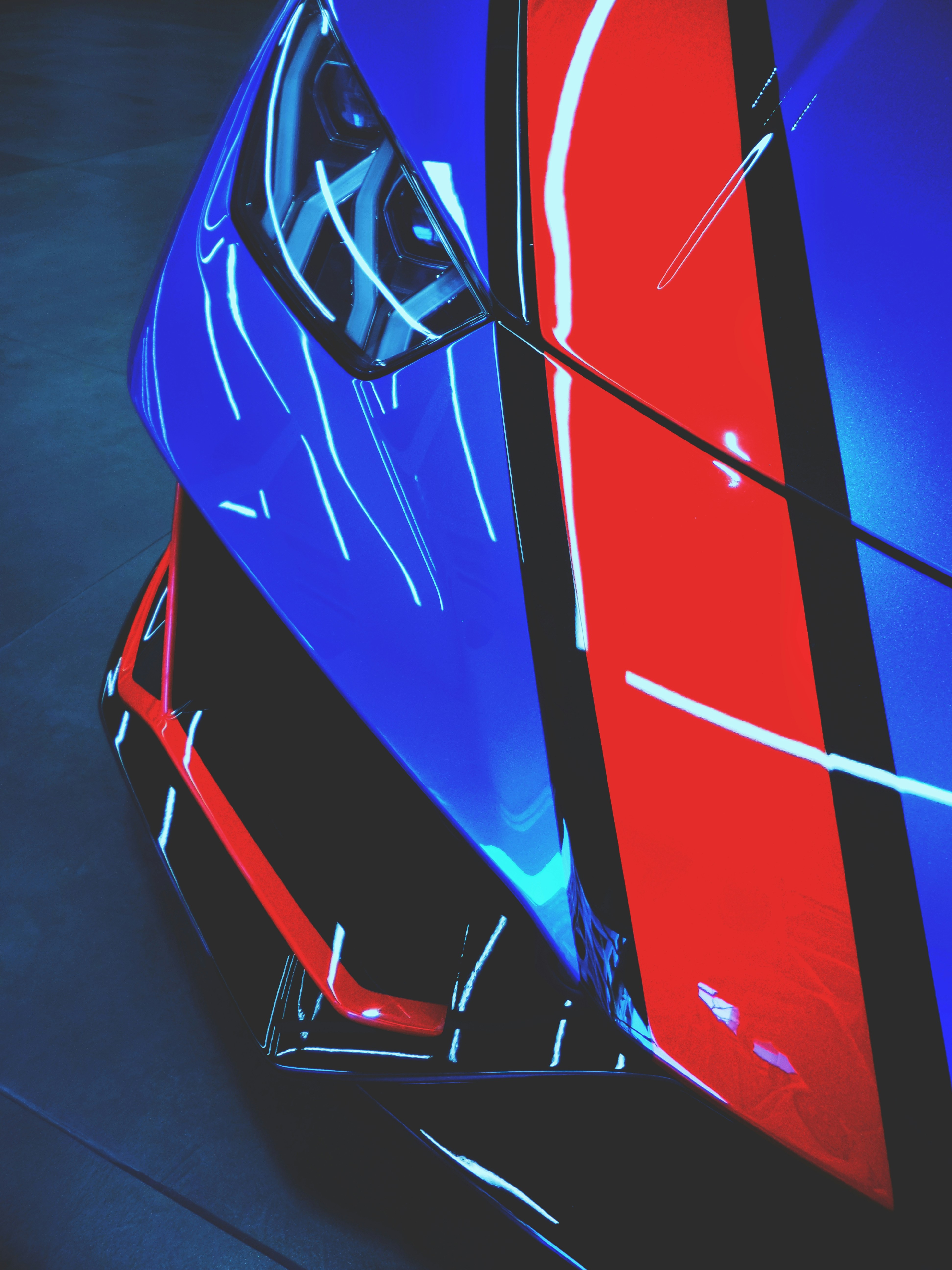 Red and blue car in a dark room photo – Free Art Image on Unsplash
