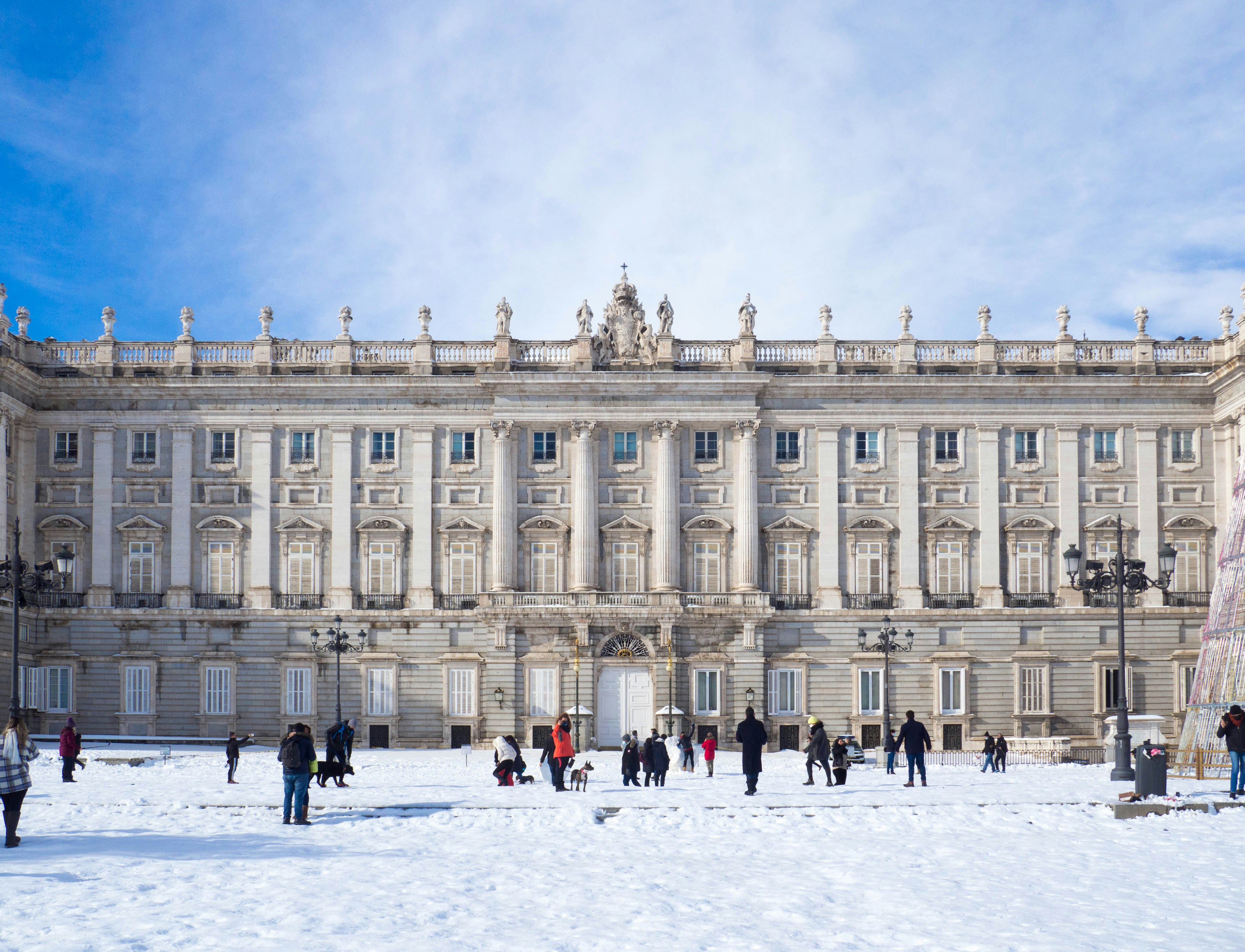 Snow-Covered Neoclassical Palace: Foot Traffic on a Winter Day