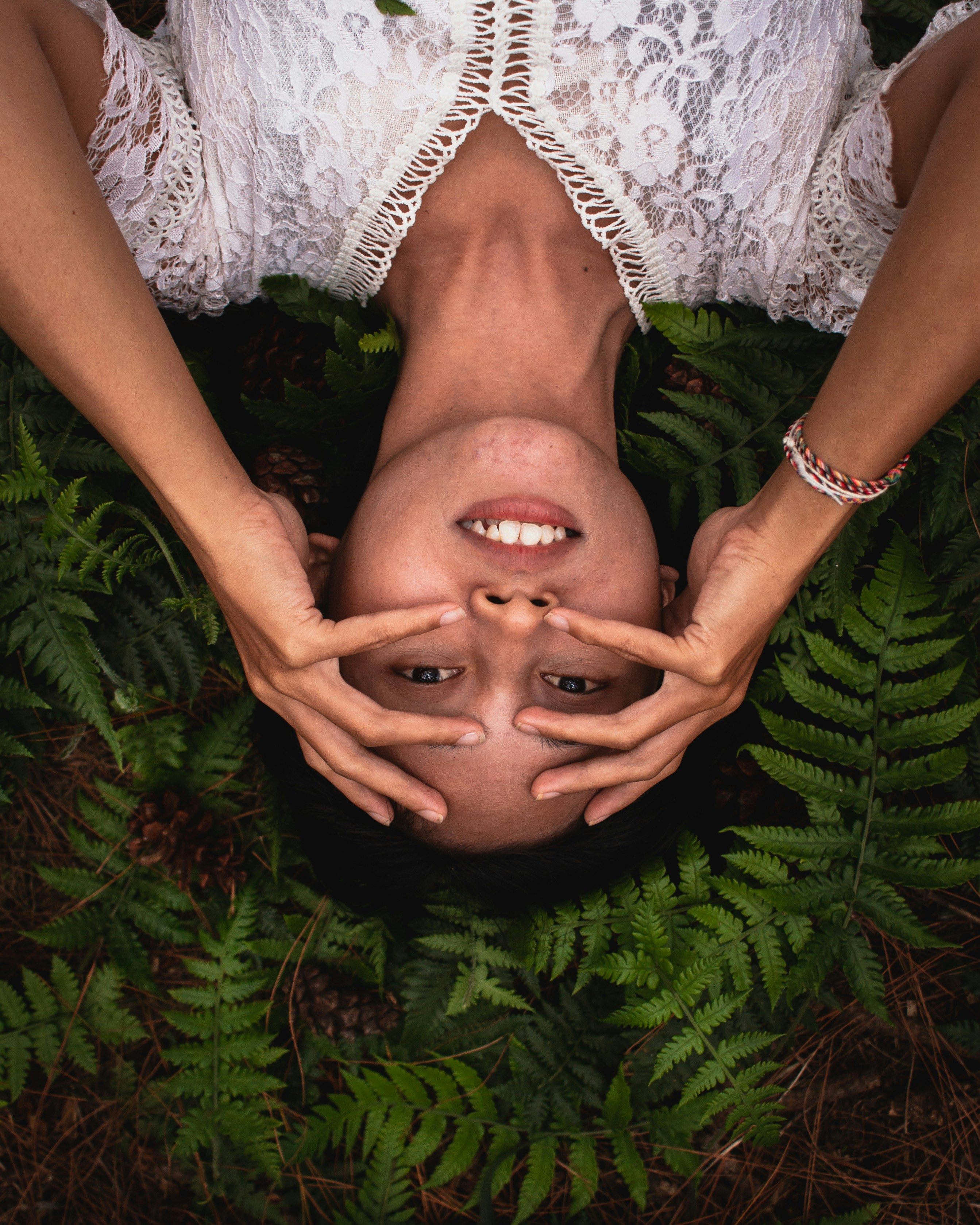 Greenery and Grin: A Playful Portrait in Fern Fronds