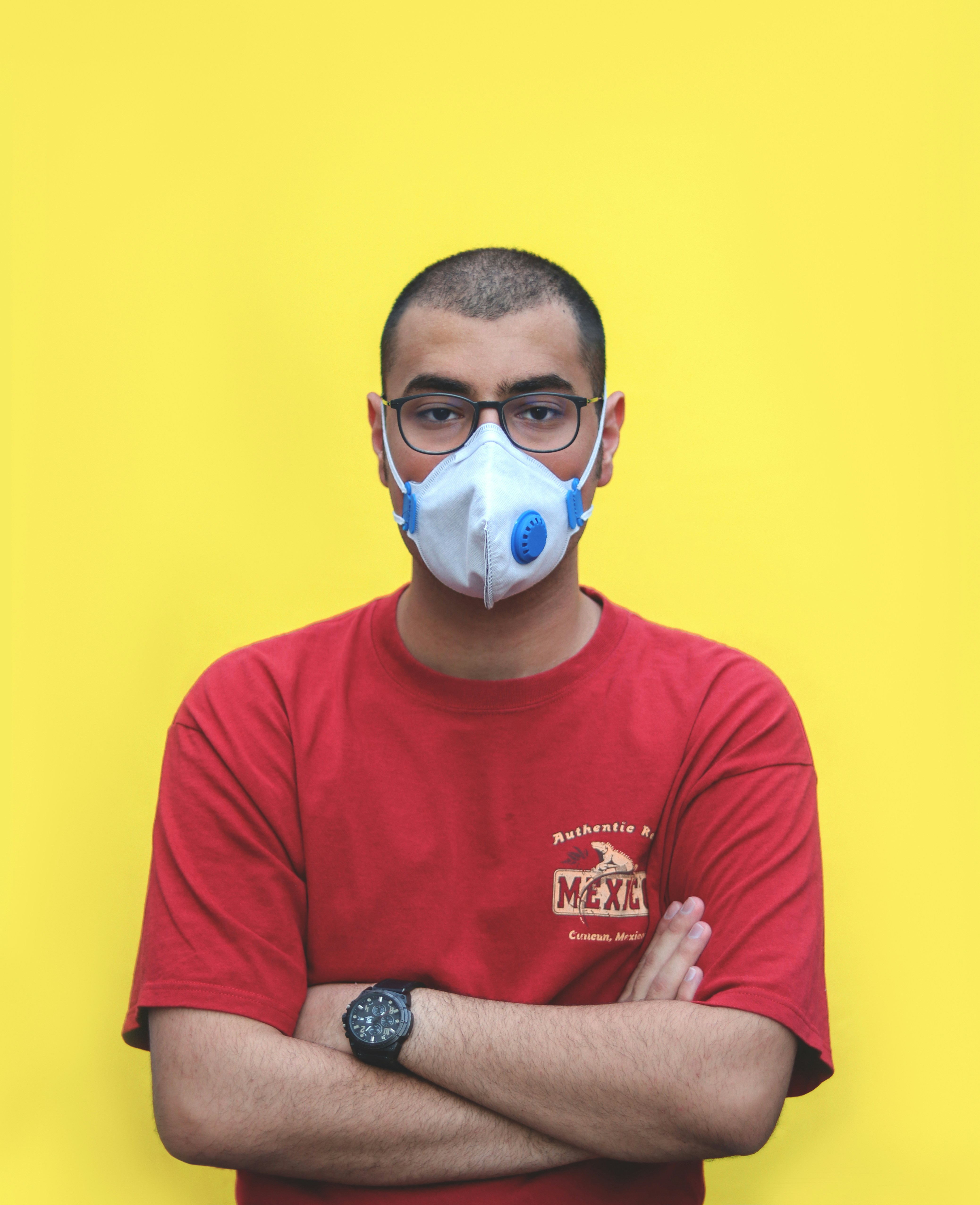 Masked Confidence: A Bold Red Tee Against Sunny Yellow