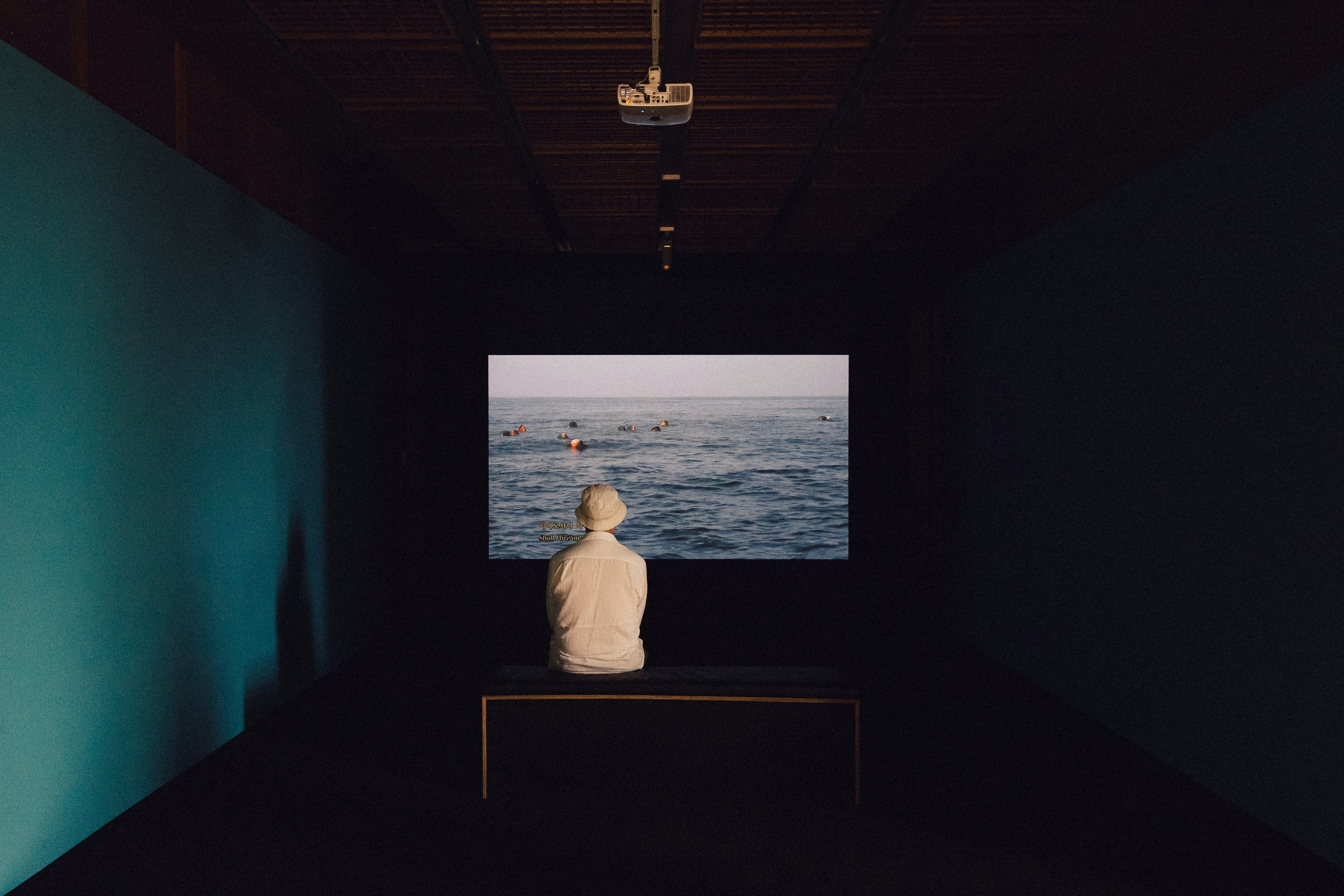 Man in white dress shirt standing in front of projector screen photo ...