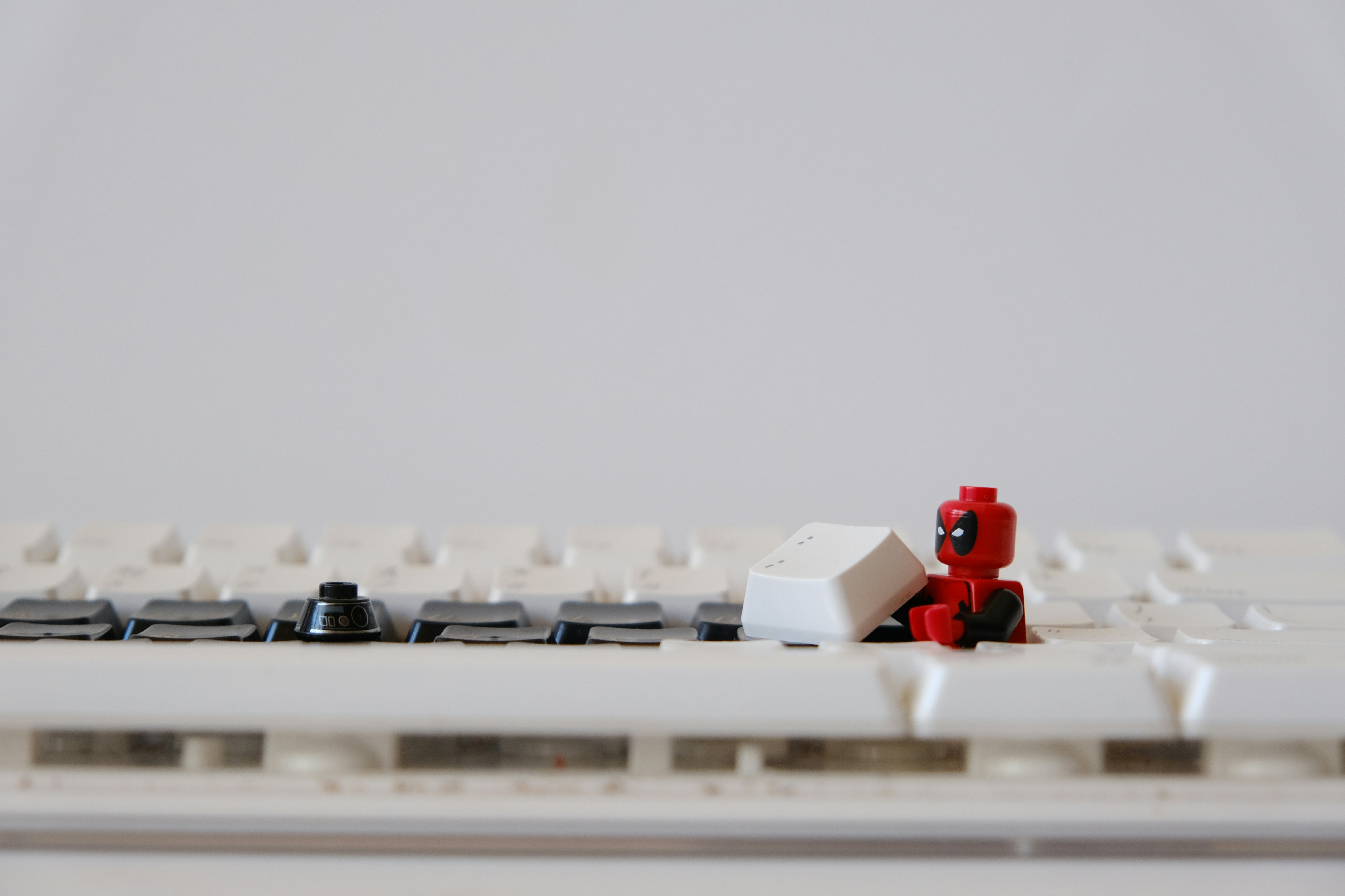 Red LEGO Sentinel on a White Keyboard Landscape