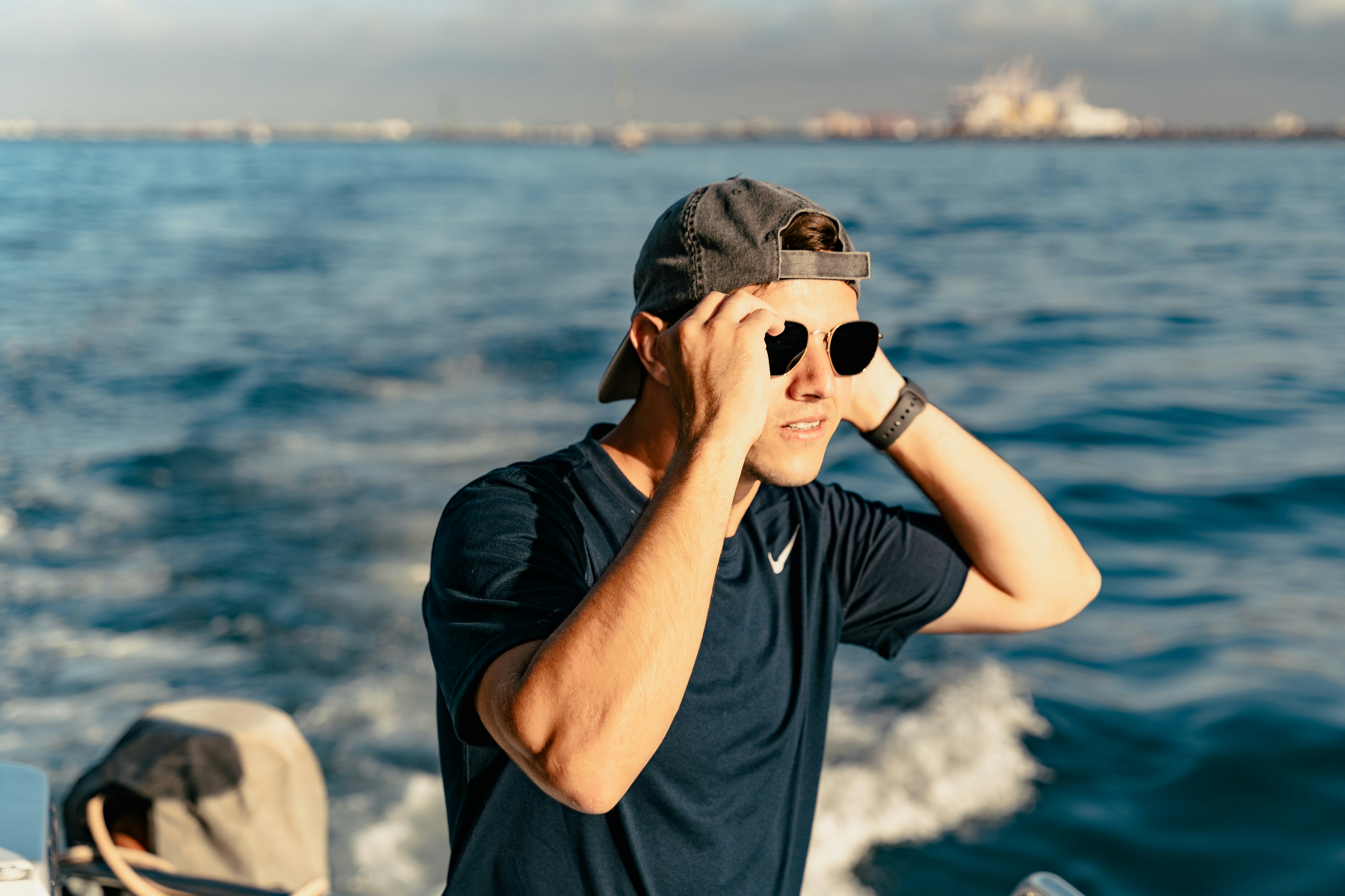 Sunlit Seafarer: A Moment of Gaze and Grip on the Water