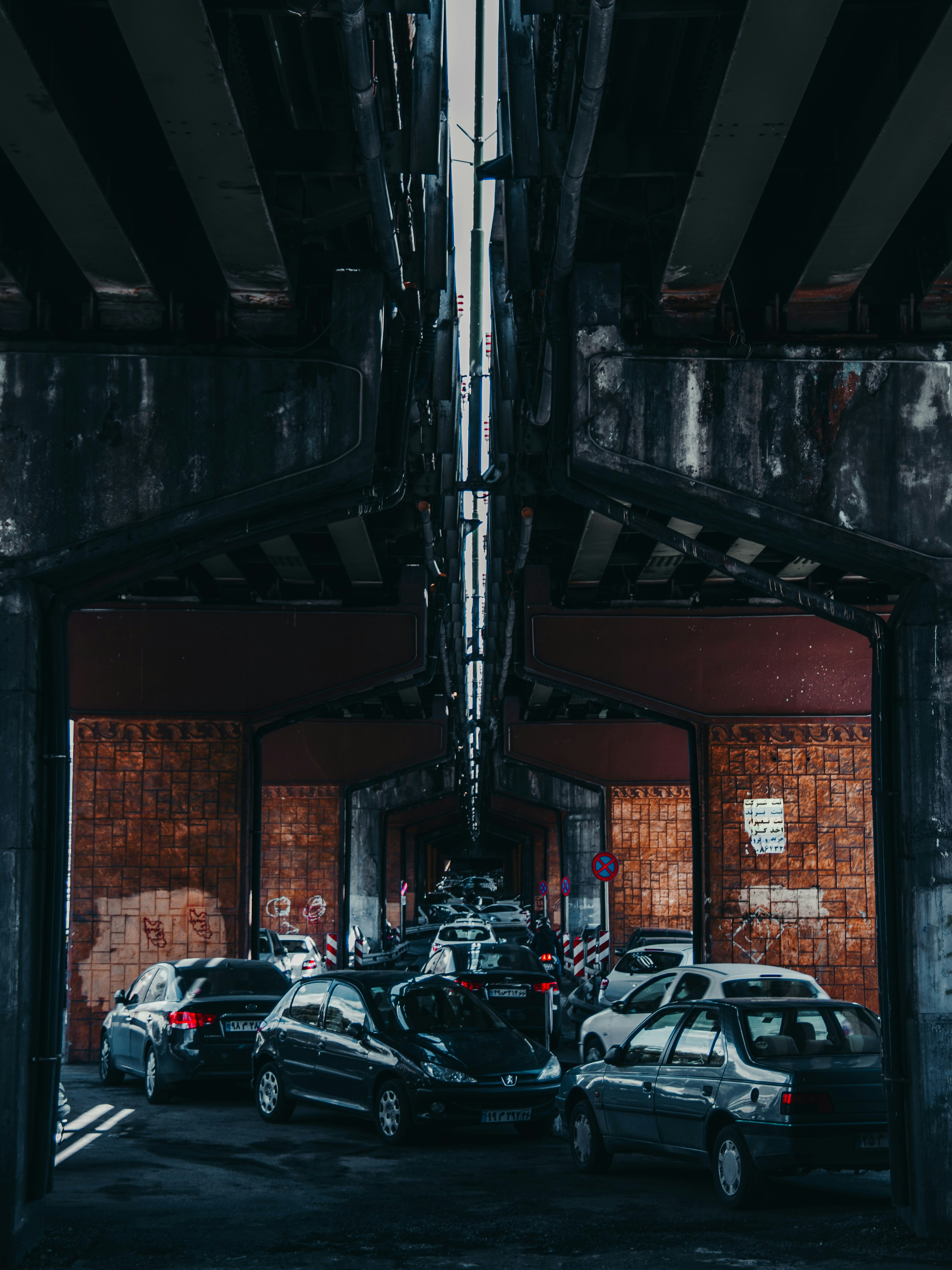 Converging Arches: A Steel-and-Brick Underpass Bursting with Traffic
