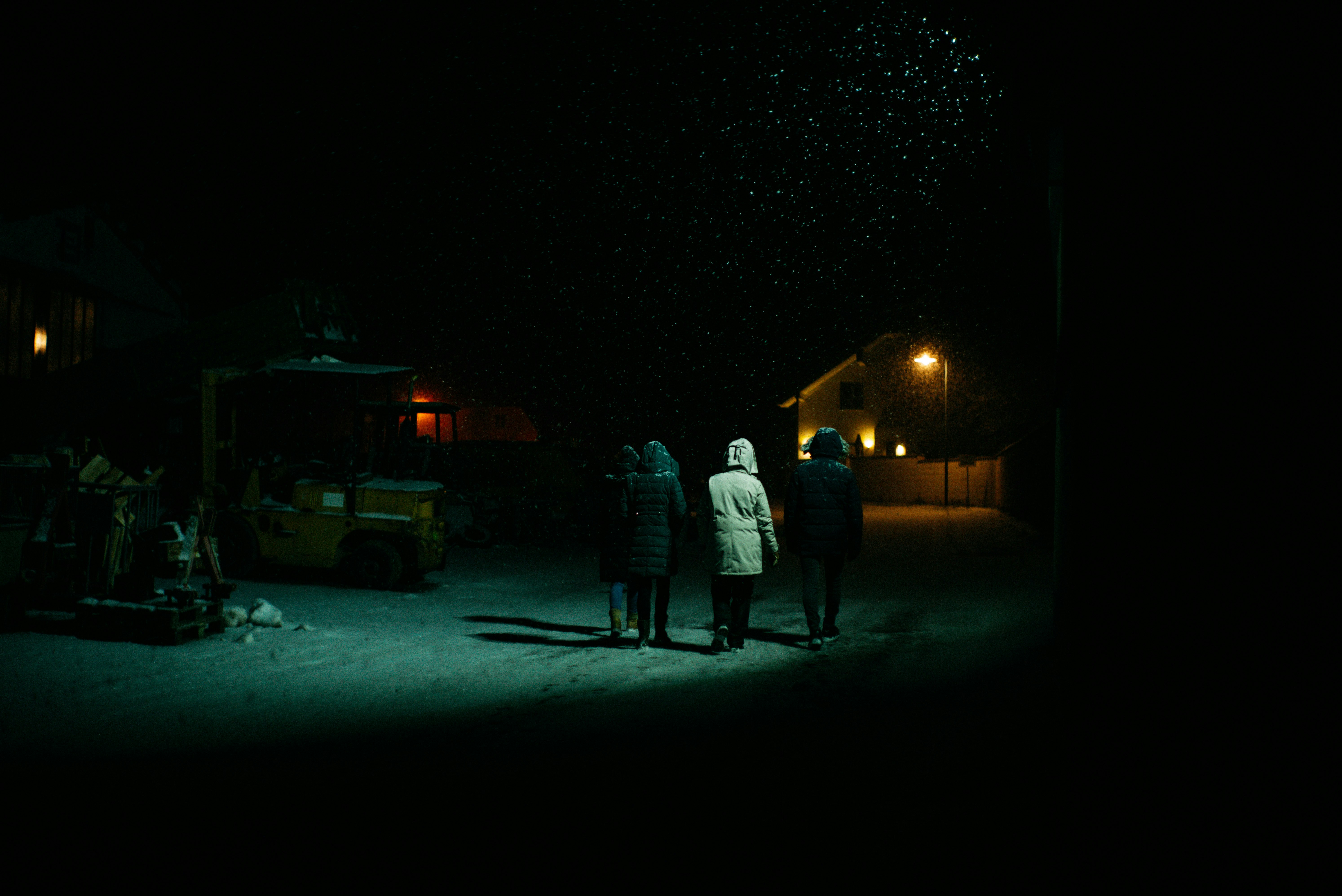 Amber Lamppost Walk: A Trio in Snowlit Silence