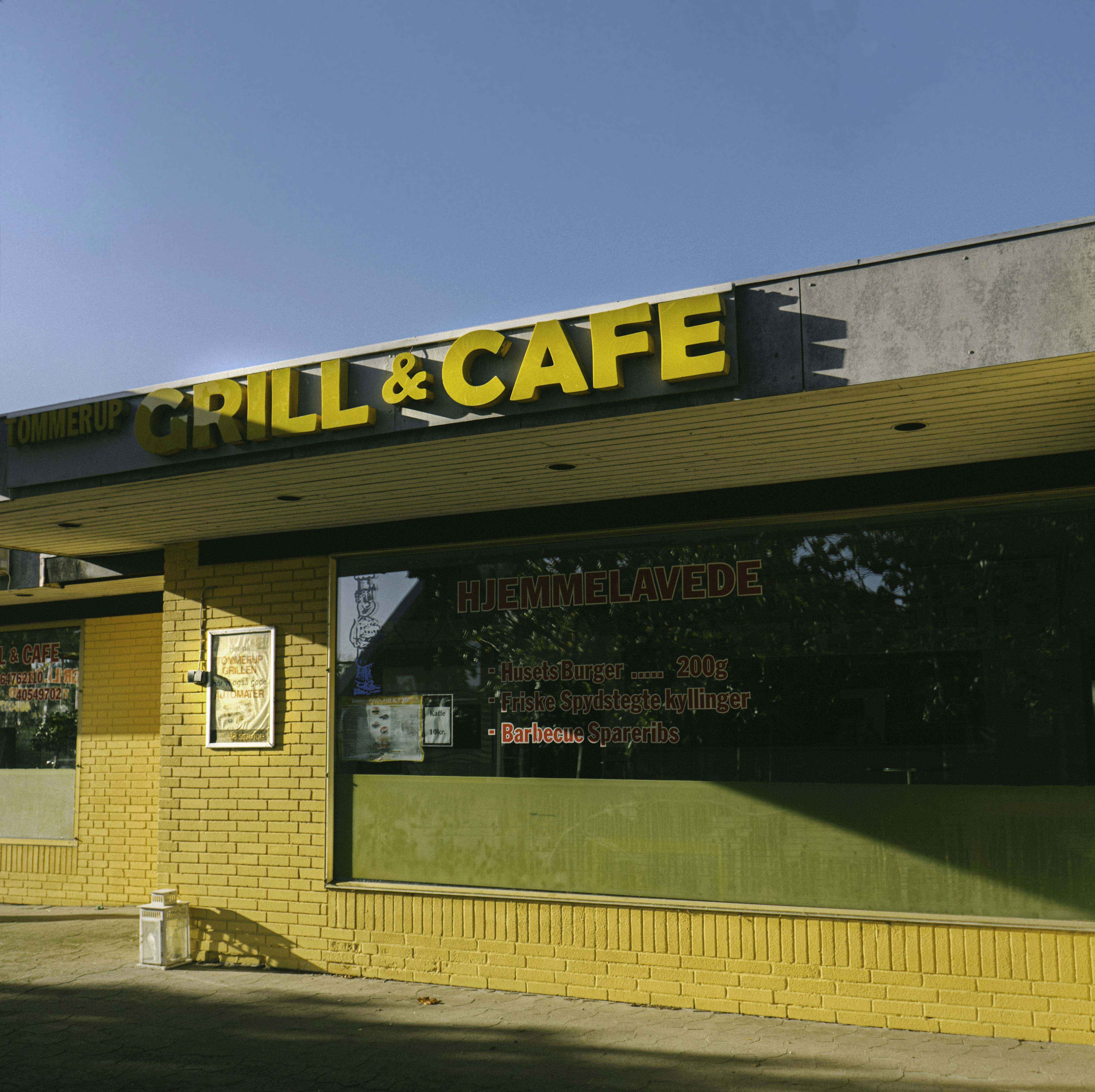 Midday Glow on a Yellow Brick Grill & Café Facade