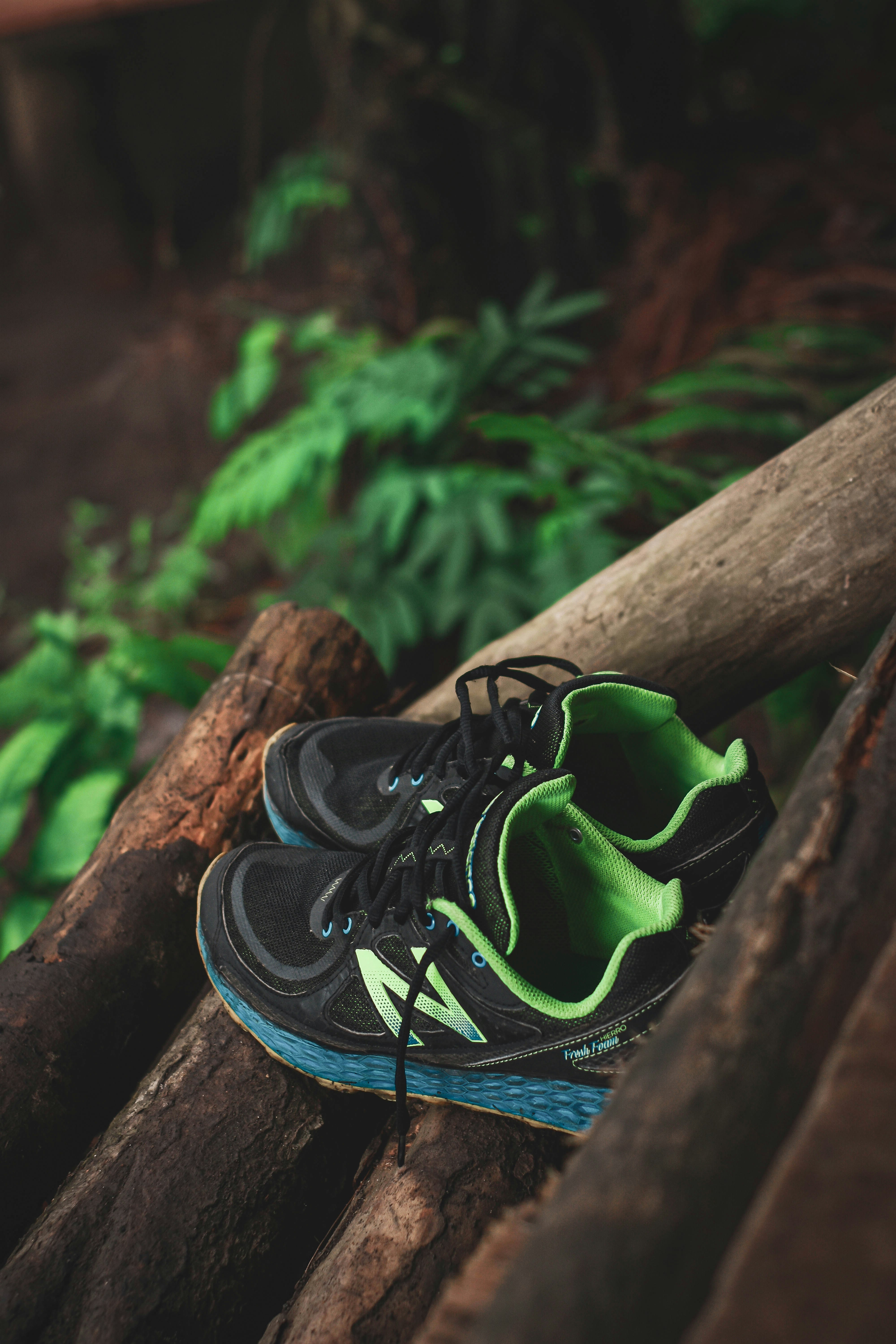 Black and green nike athletic shoes on brown wooden log photo – Free ...