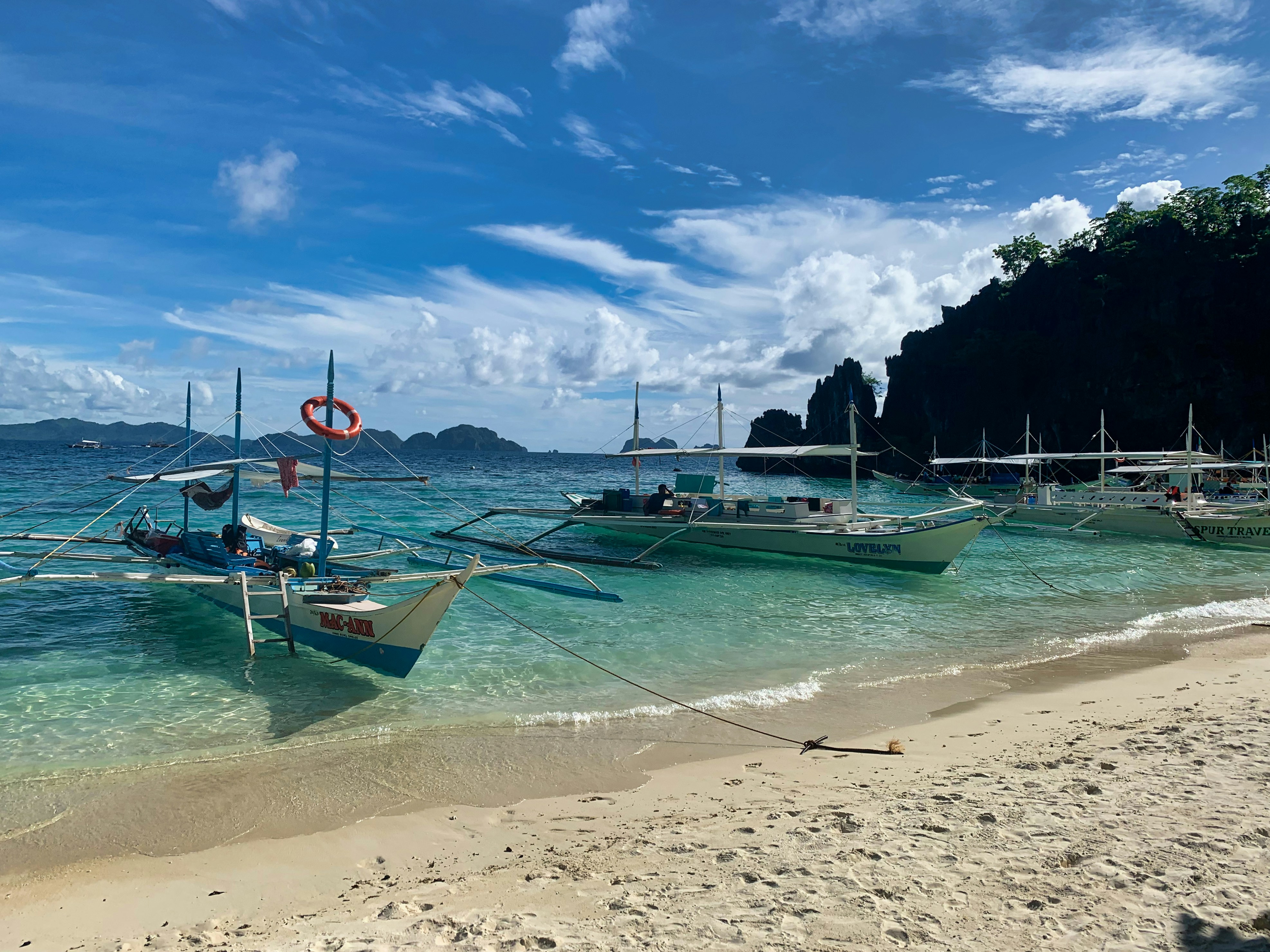 Azure Cove: Traditional Fishing Boats Rest Along a Sunlit Shore
