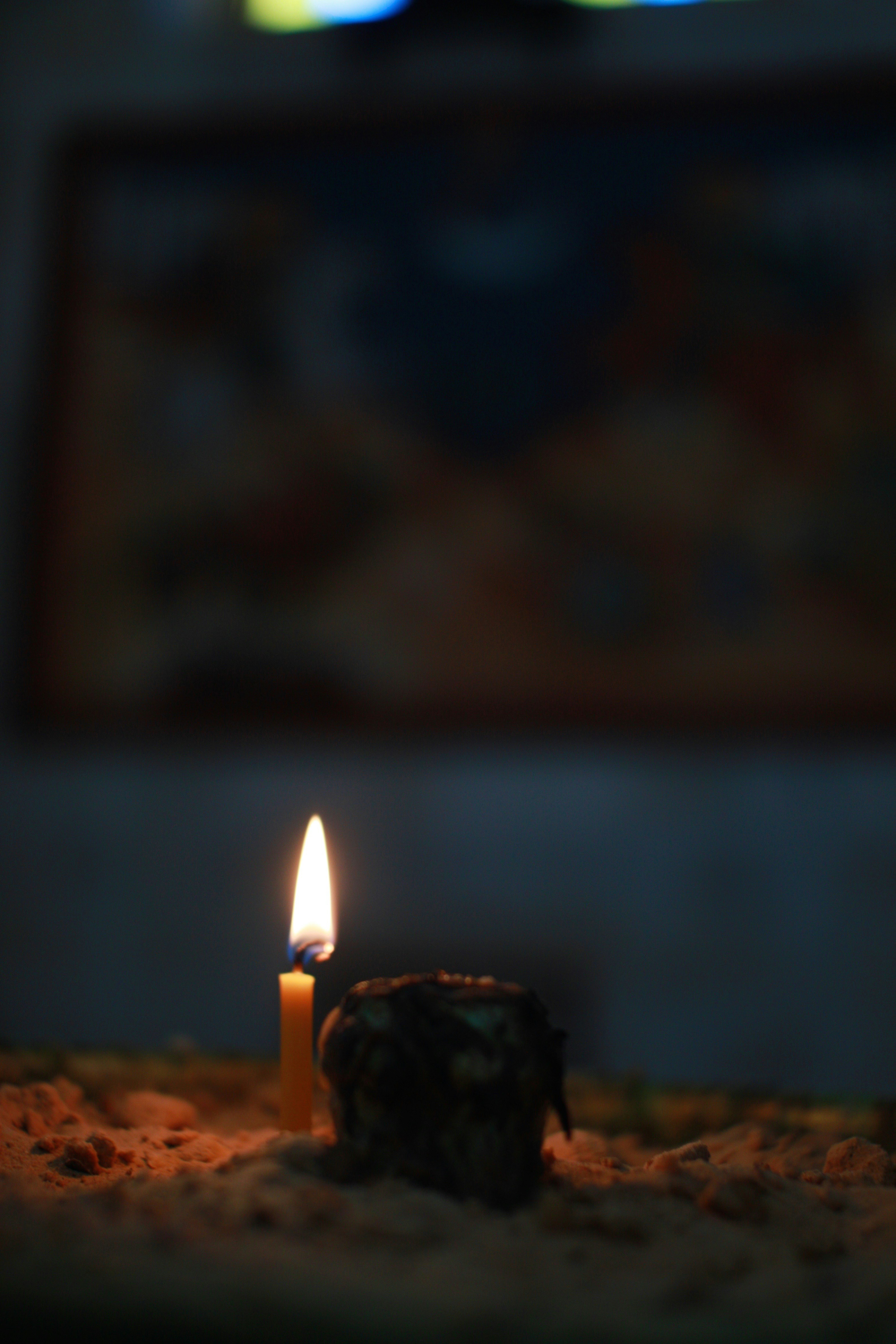 lighted candle on brown wooden table
