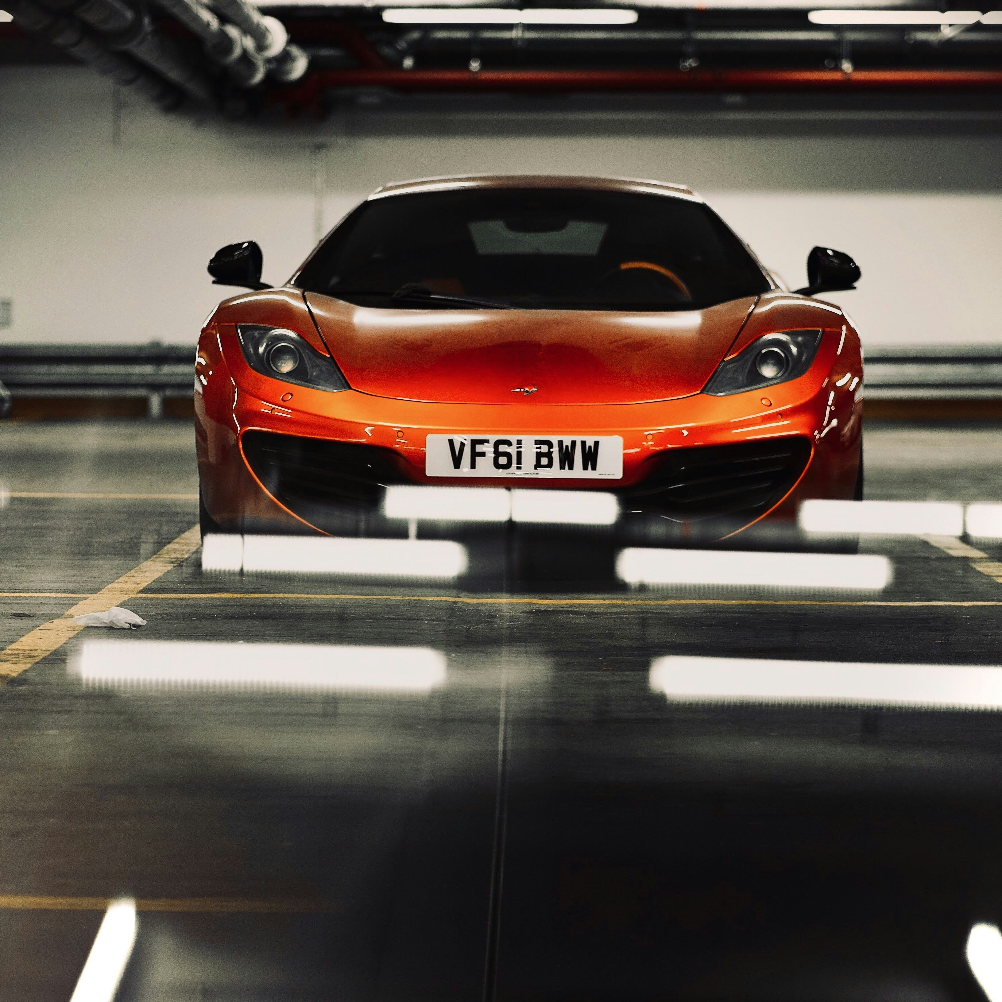 Ember Front: A Crimson Sports Car Anchored in a Dim Underground Garage