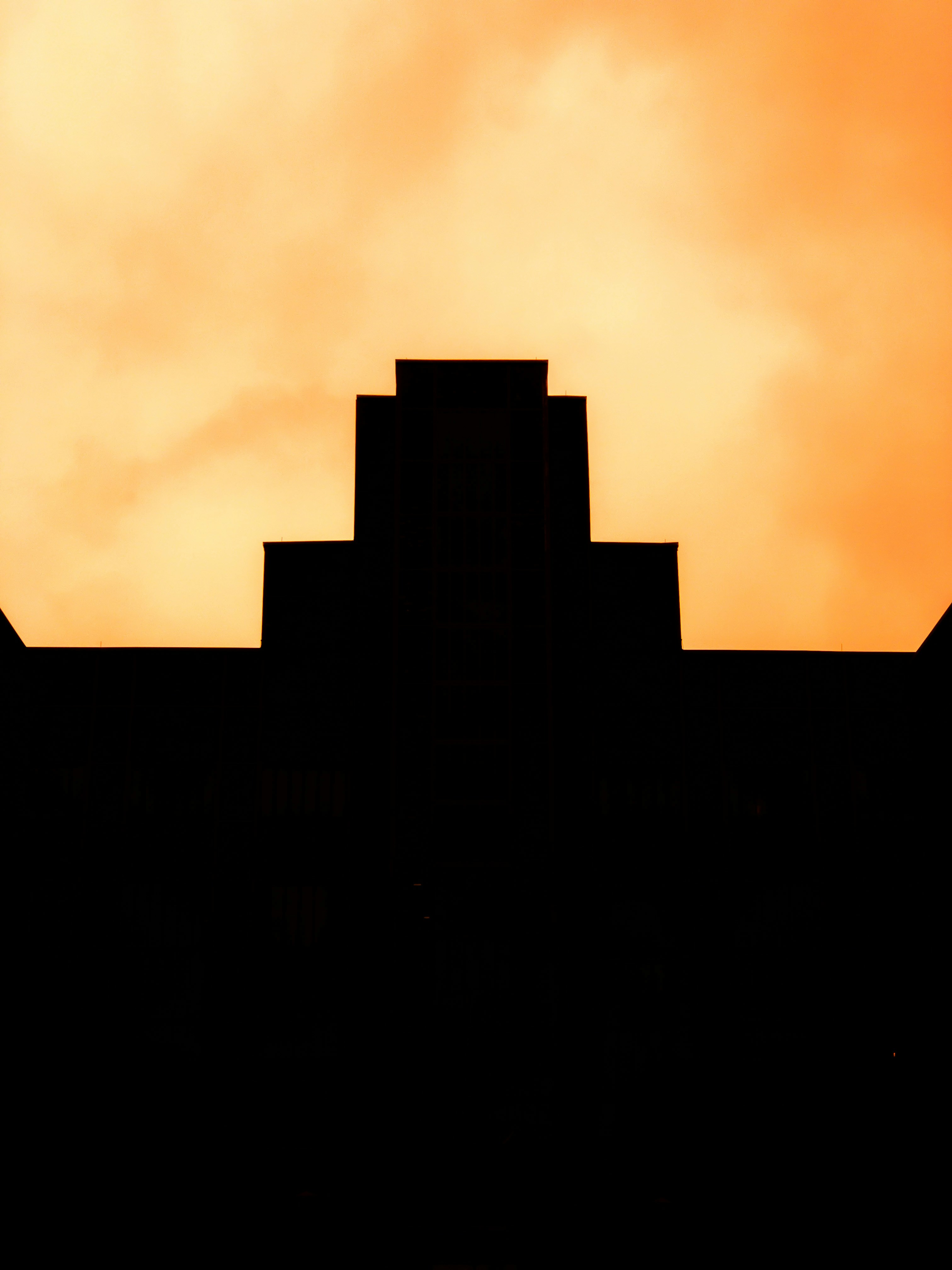 Molten Sunset Crown: A Central Step-Shape Silhouette Against a Fiery Sky