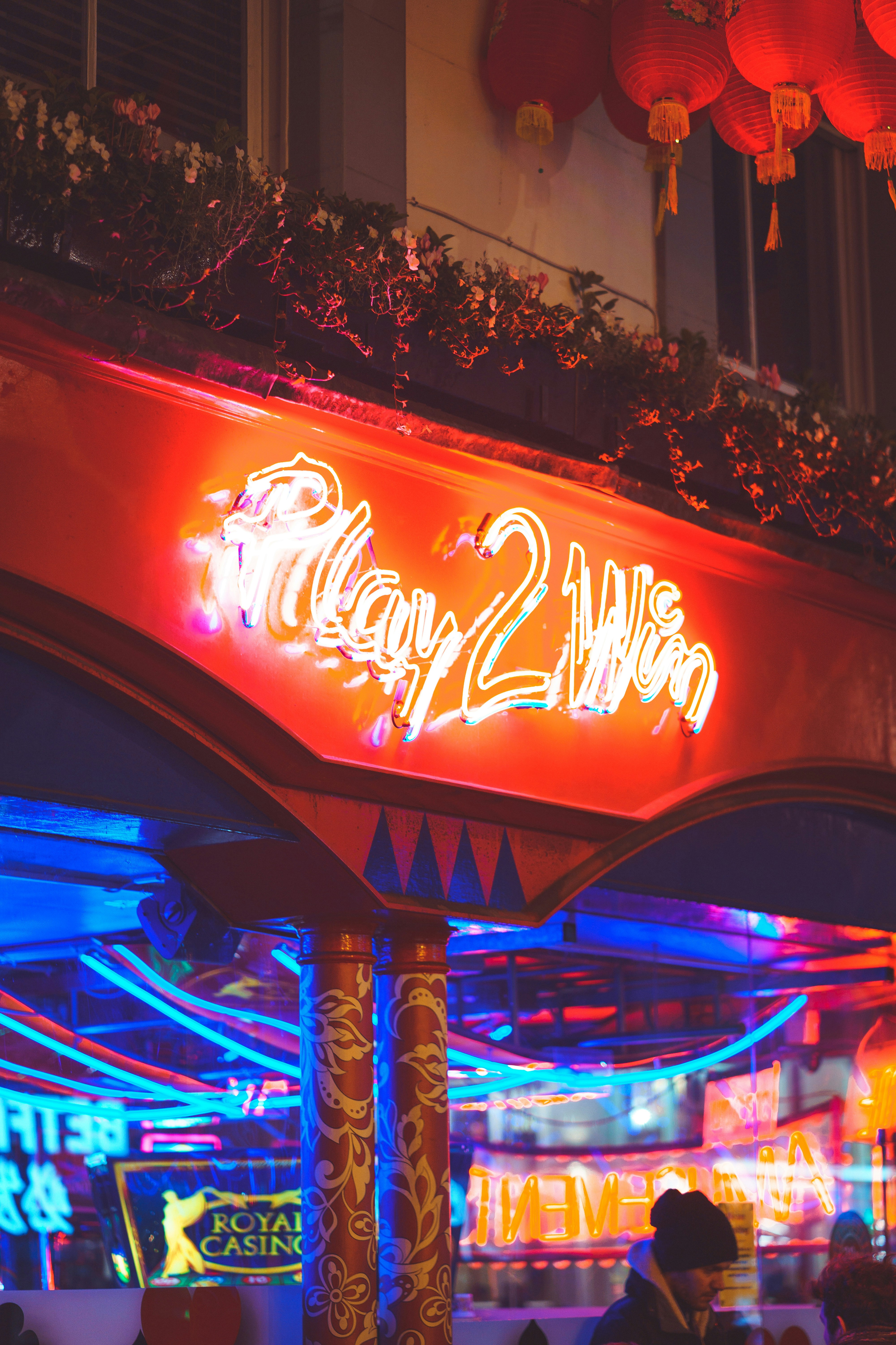 May2Win Neon: Red Script Over a Blue-Glow Casino Street