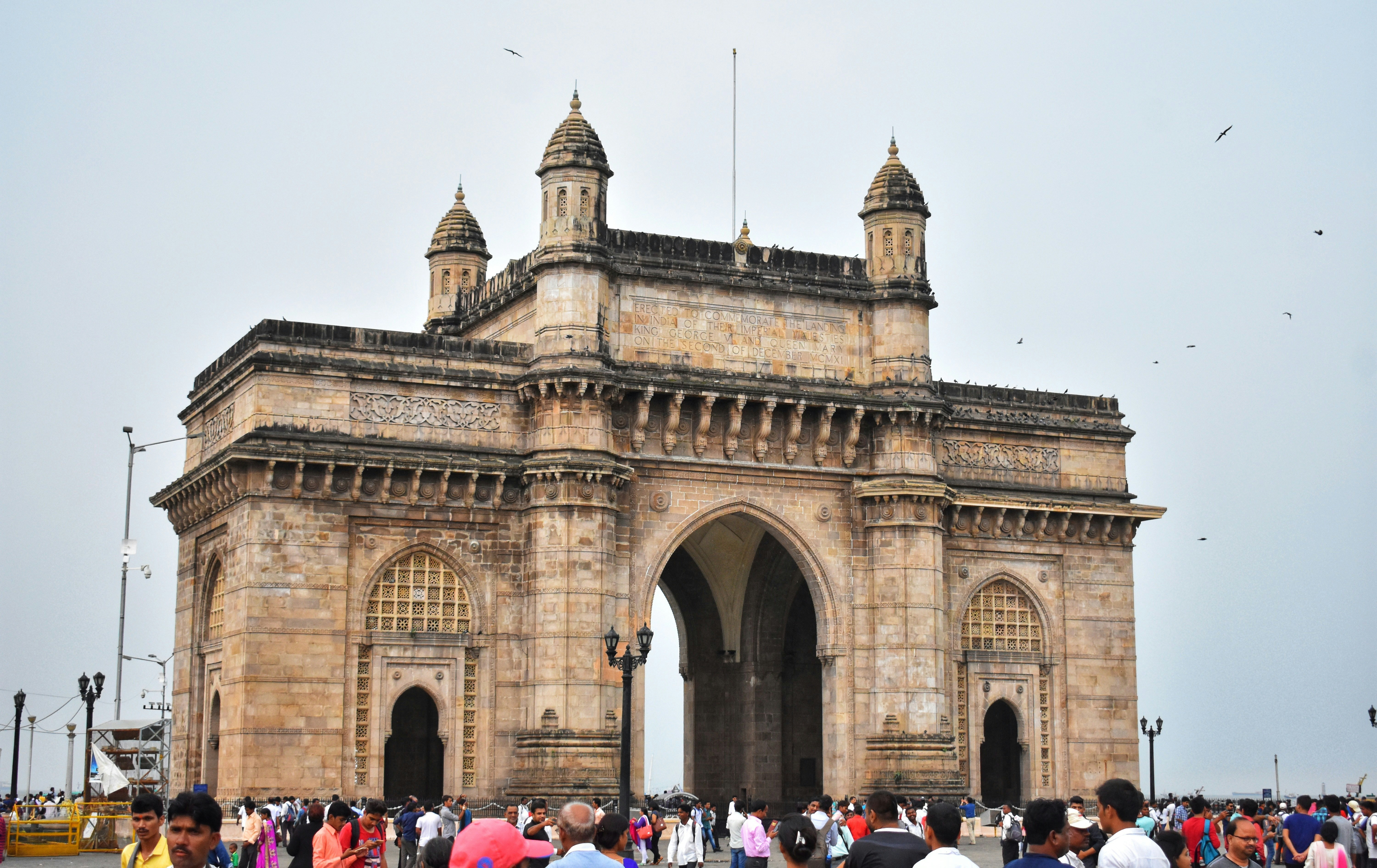 Gateway of India under a muted sky: crowds converge before the grand arch