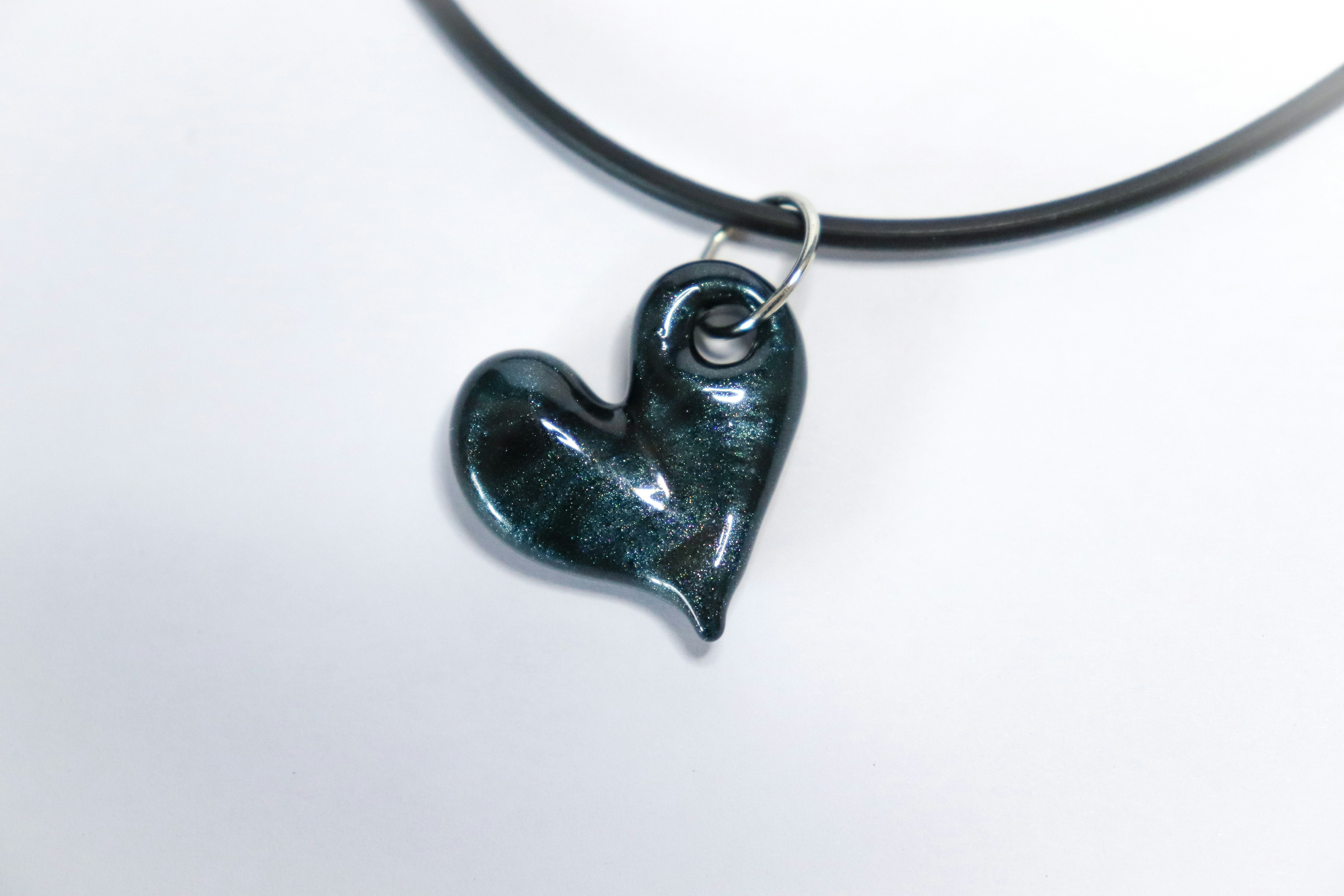 Luminous Heart Pendant Against White: A Minimalist Jewelry Portrait