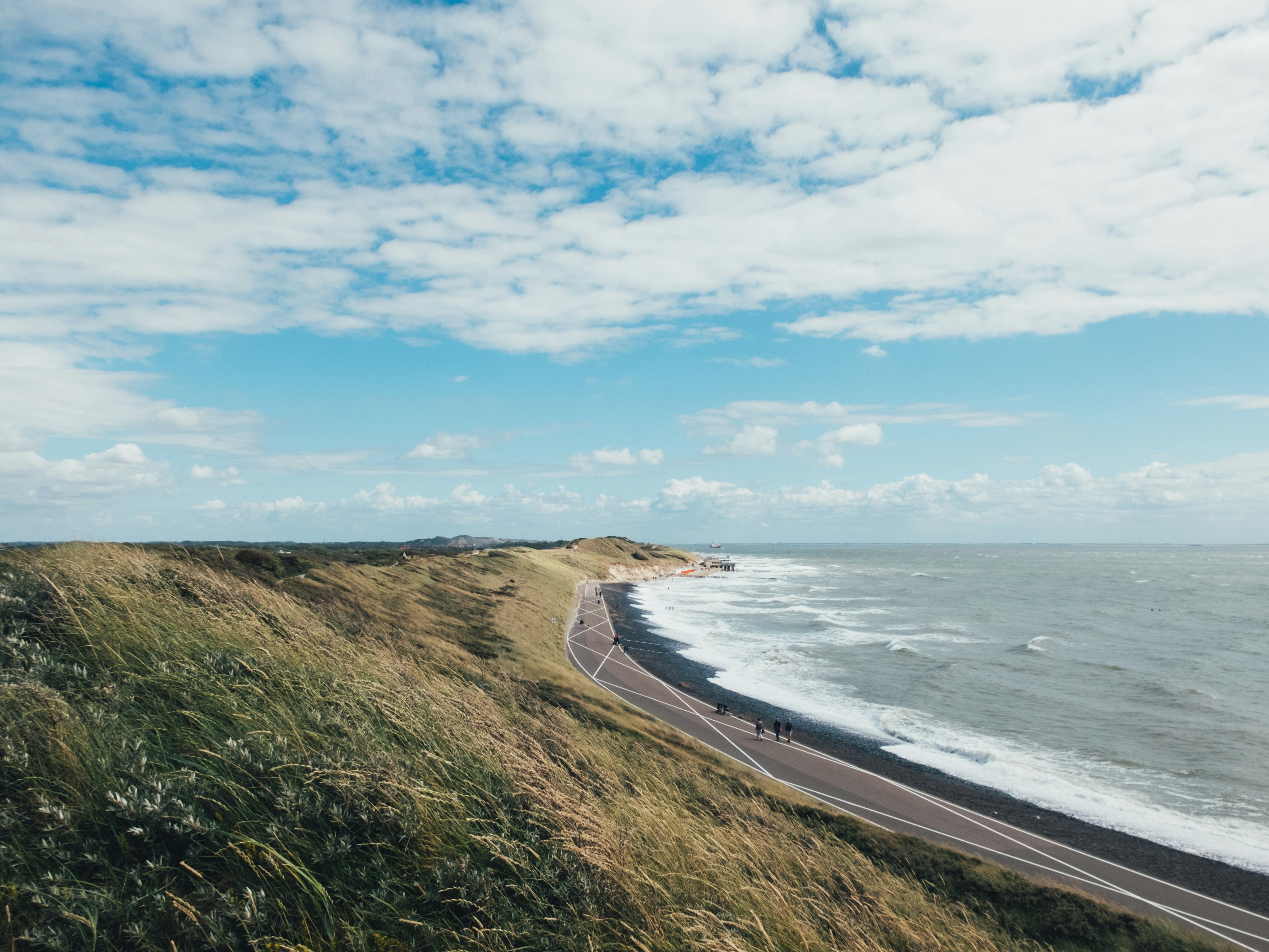 Green grass field near sea under blue sky during daytime photo – Free ...