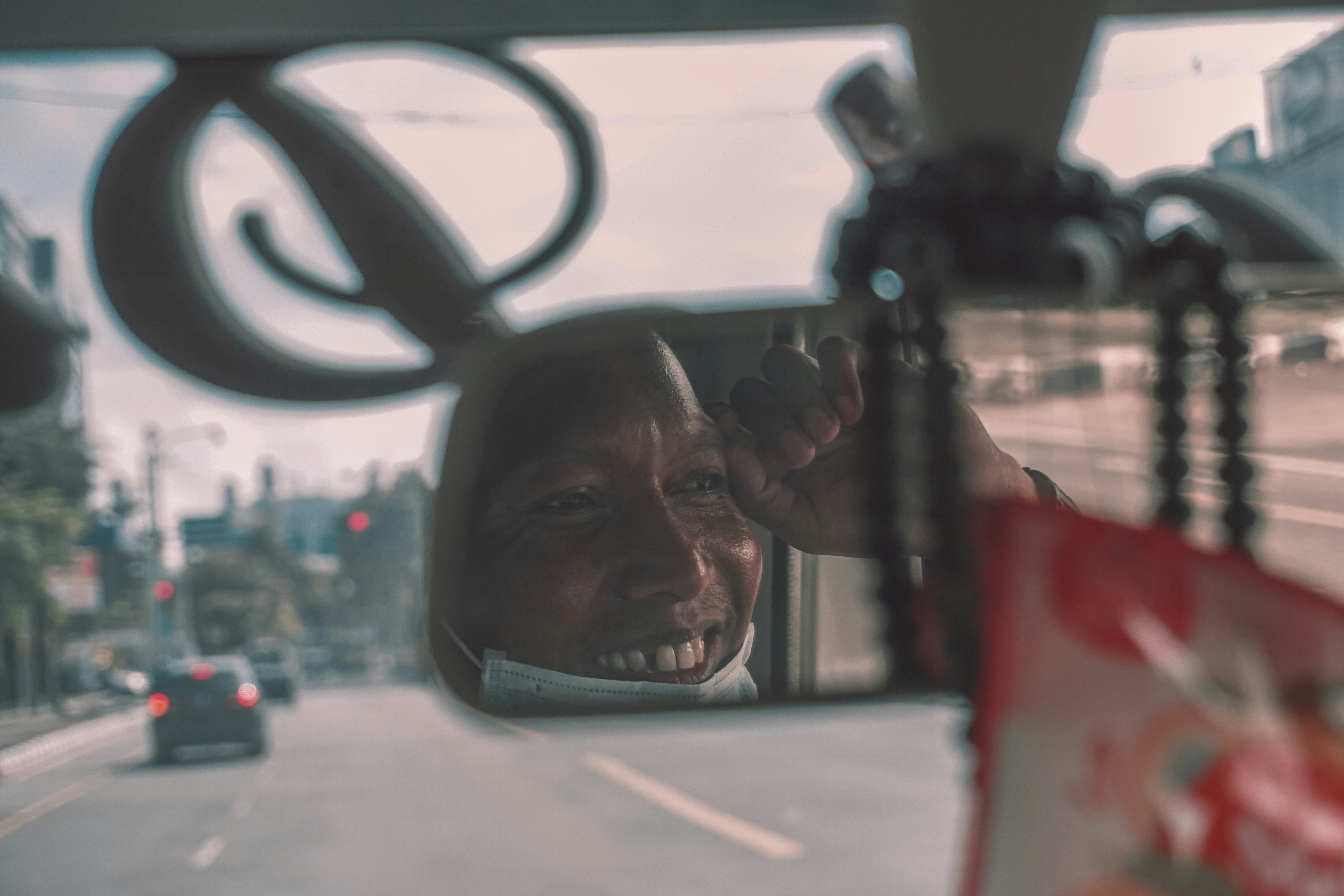 Rearview Portrait: A City Smile Reflected in Glass