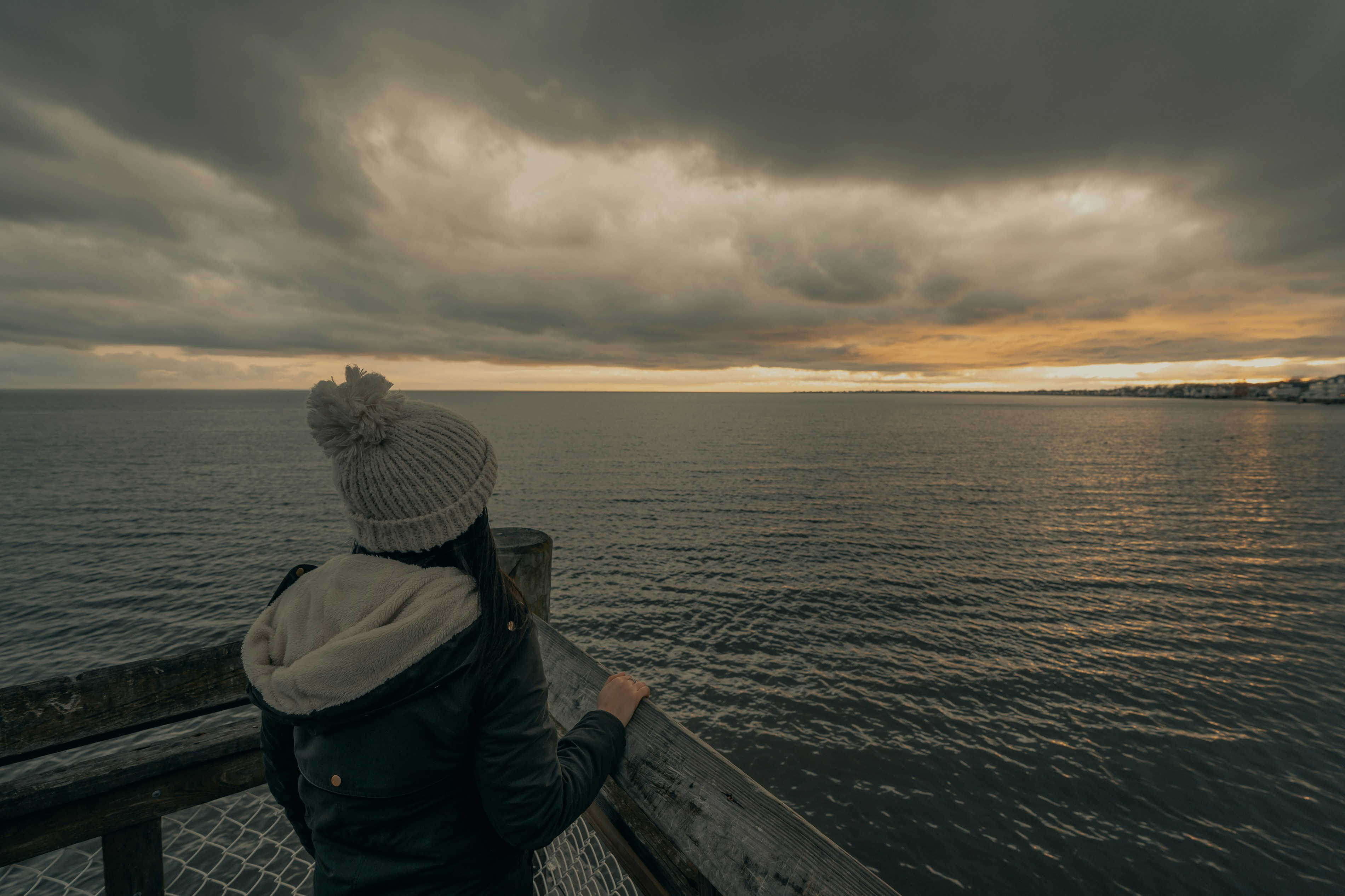 Dusk on the Pier: A Quiet Figure Watching the Sea