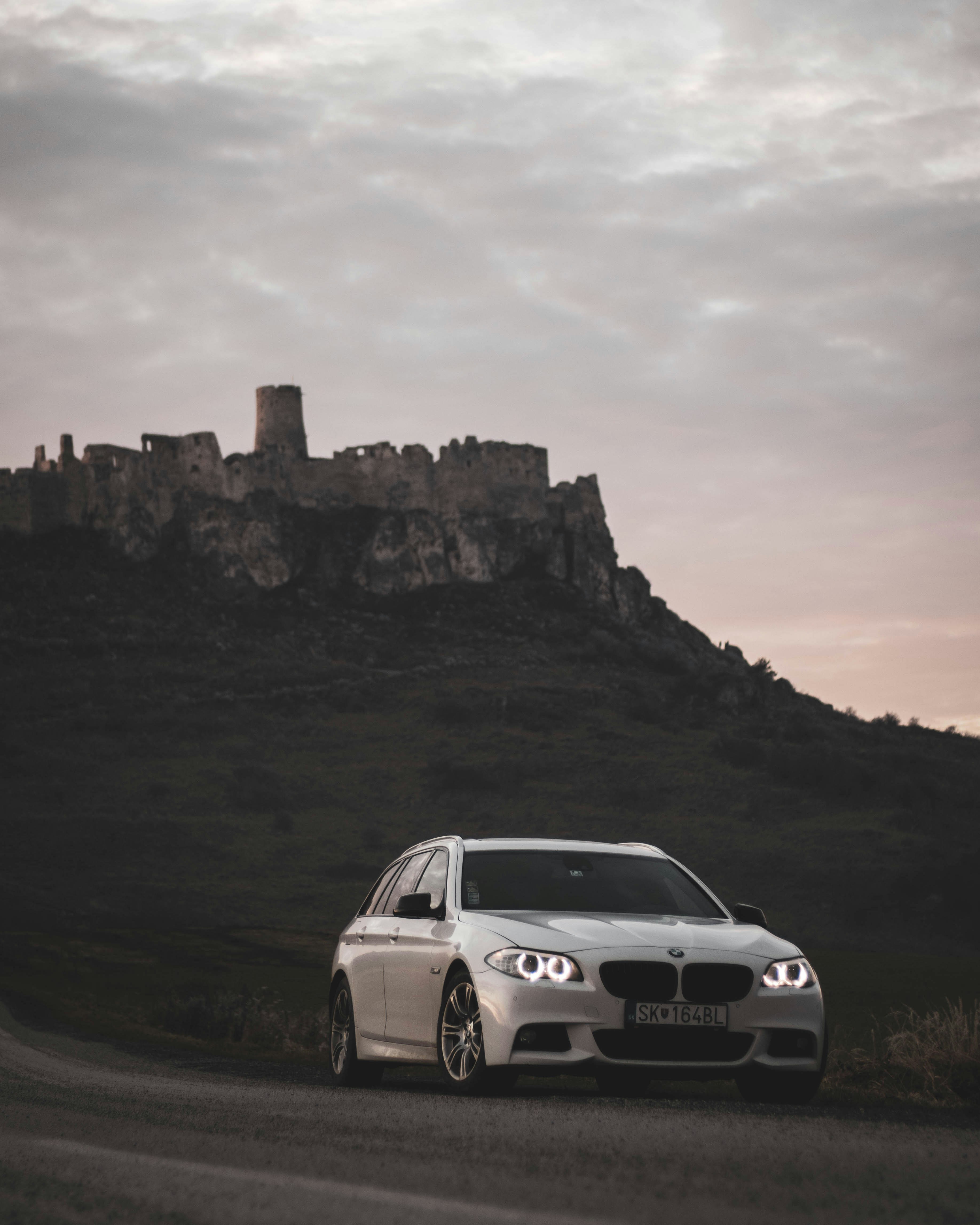 White BMW at Sunset Foot of an Ancient Ruined Citadel
