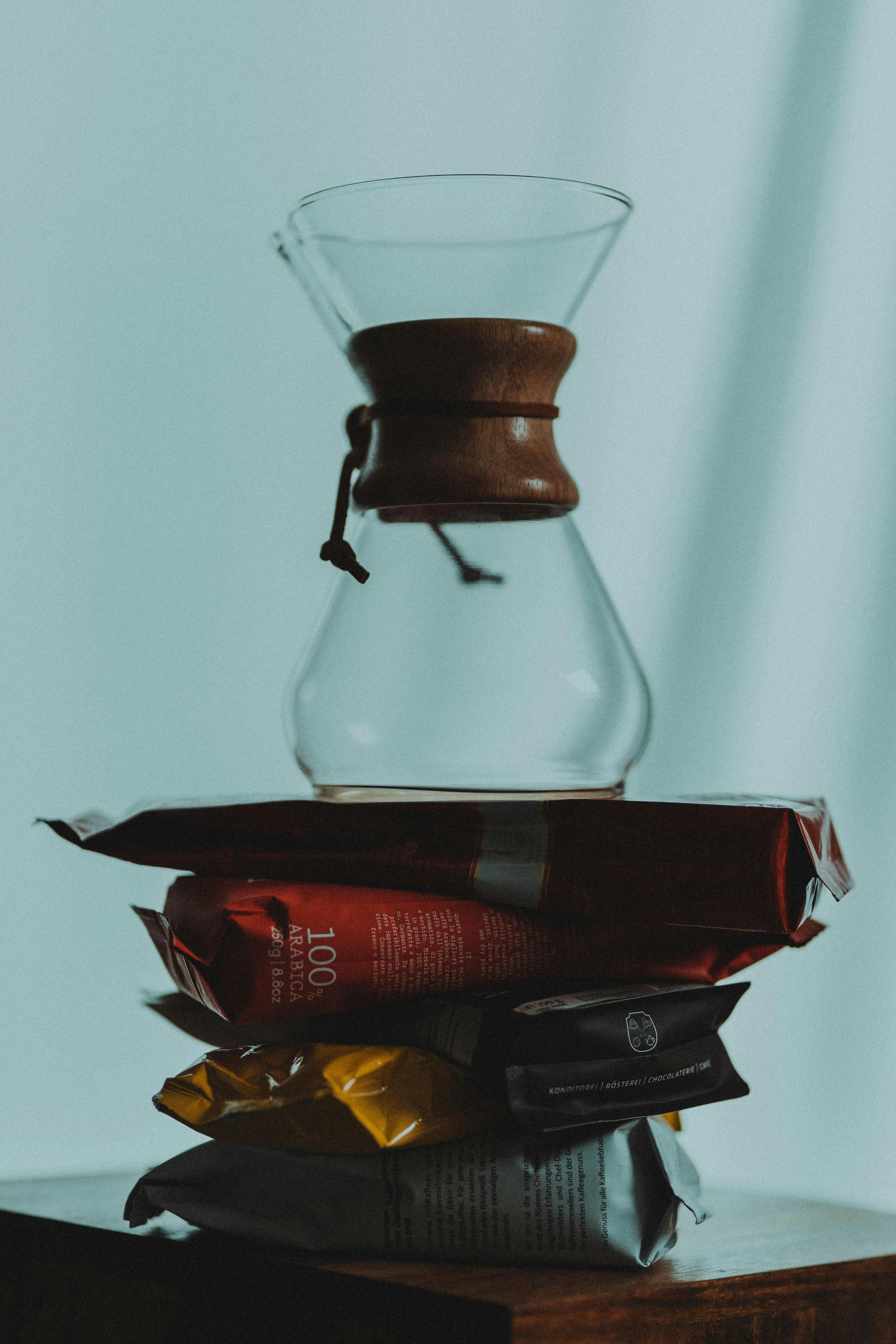 Glass Crown: A Carafe Balancing on a Stack of Snack Bags