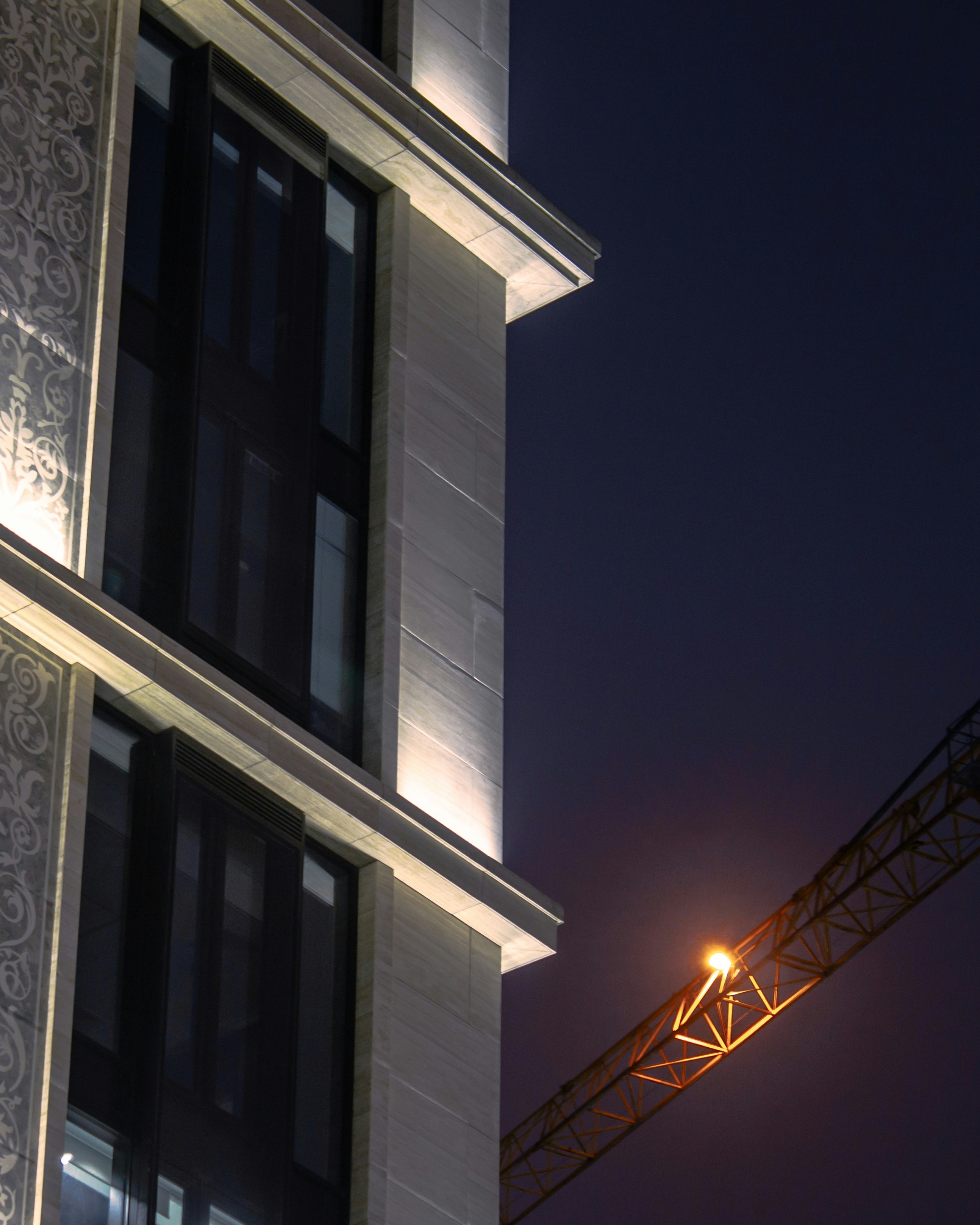 Luminous Facade: Night Construction Under Warm Glow