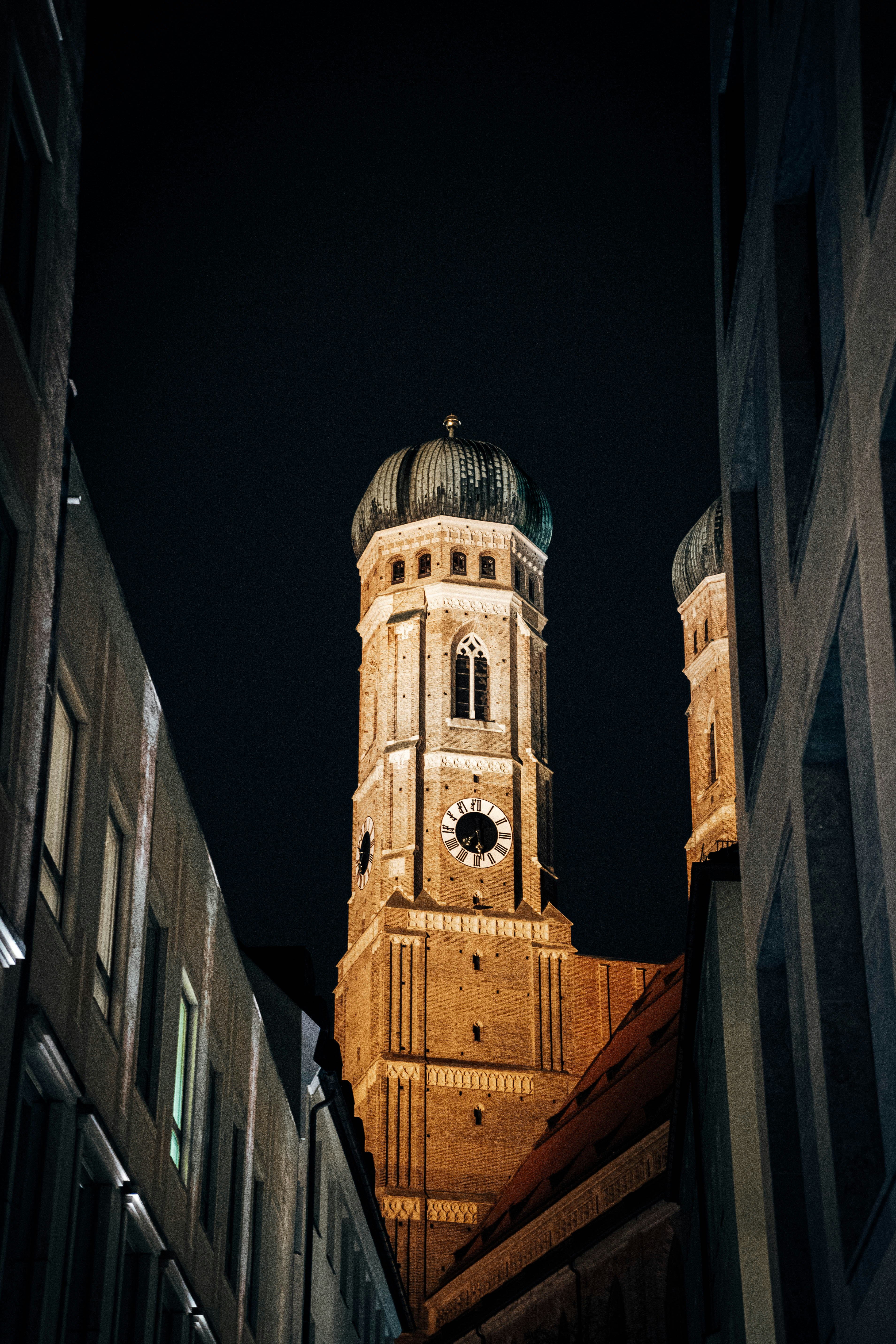 Moonlit Clocktower Rising Between Narrow City Walls