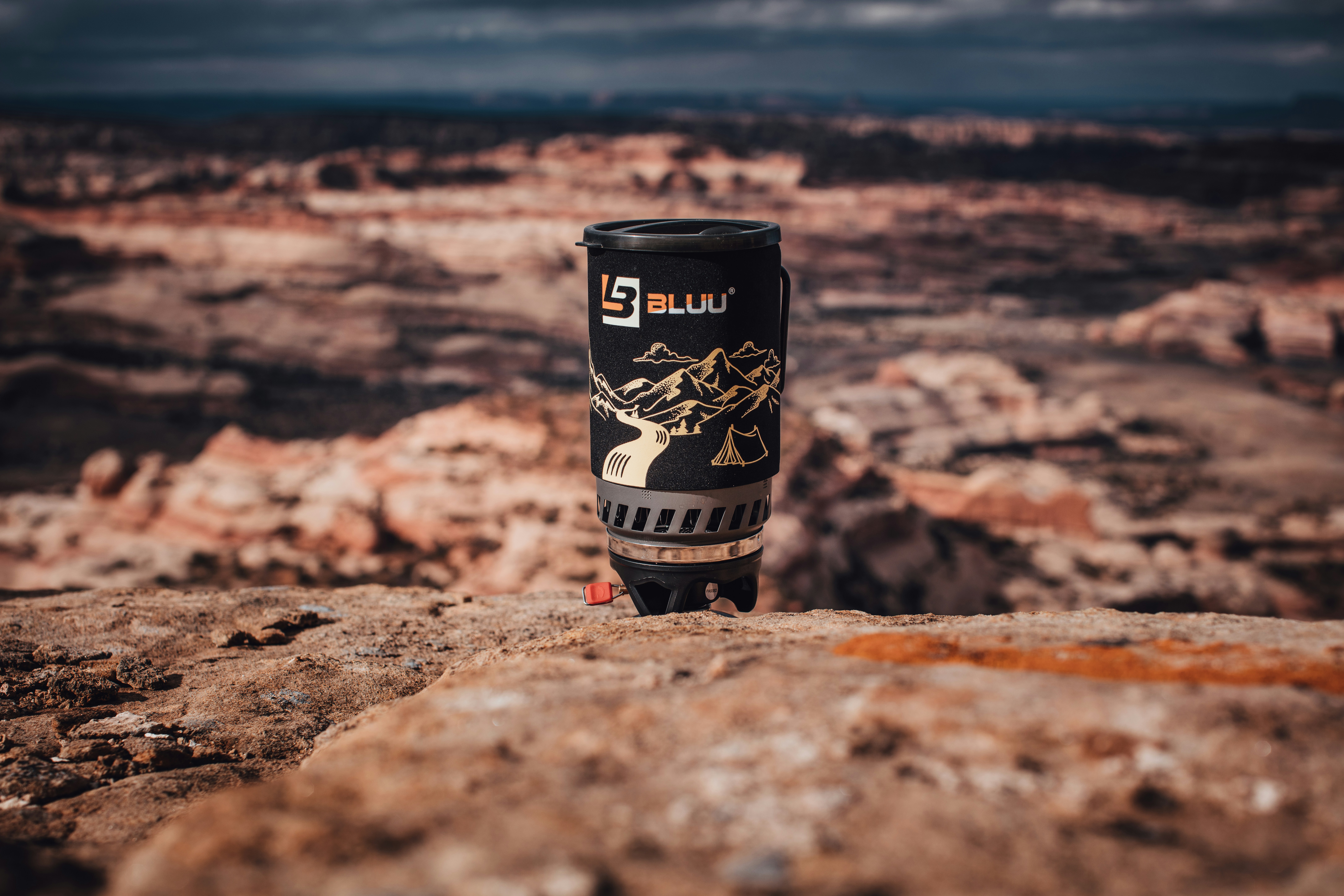 Desert Summit: A Can of Adventure Stands Guard on Weathered Rock