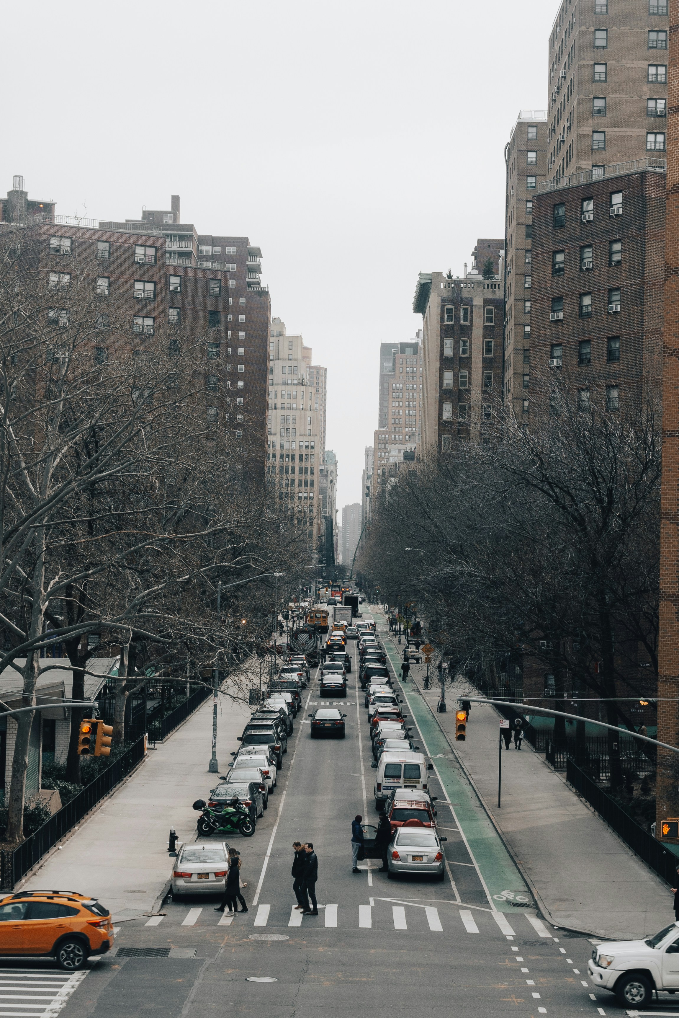 People walking on sidewalk near high rise buildings during daytime ...