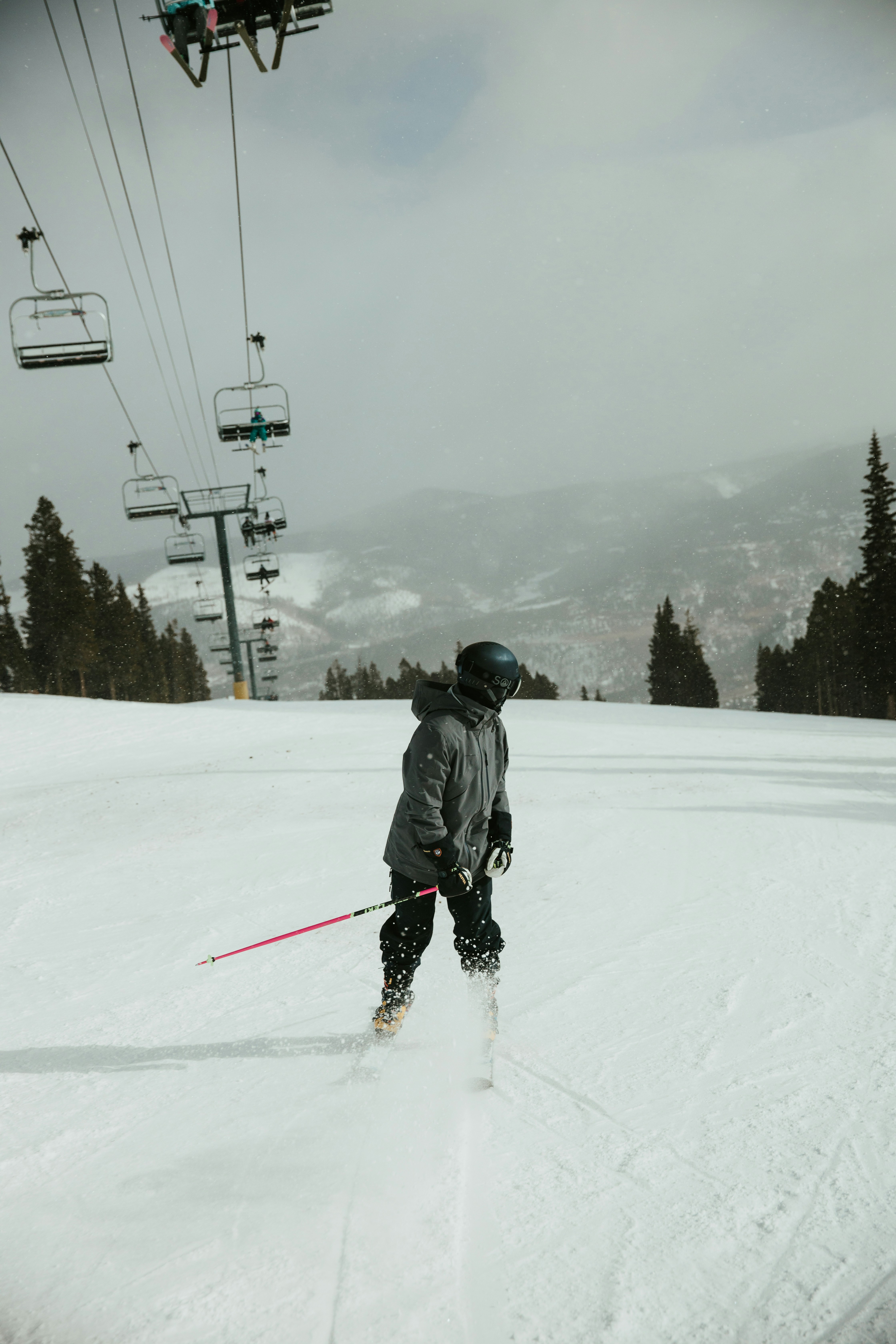 Powder Under the Lift: A Solo Skier Traces Fresh Lines Beneath a Snow-Capped Chairlift