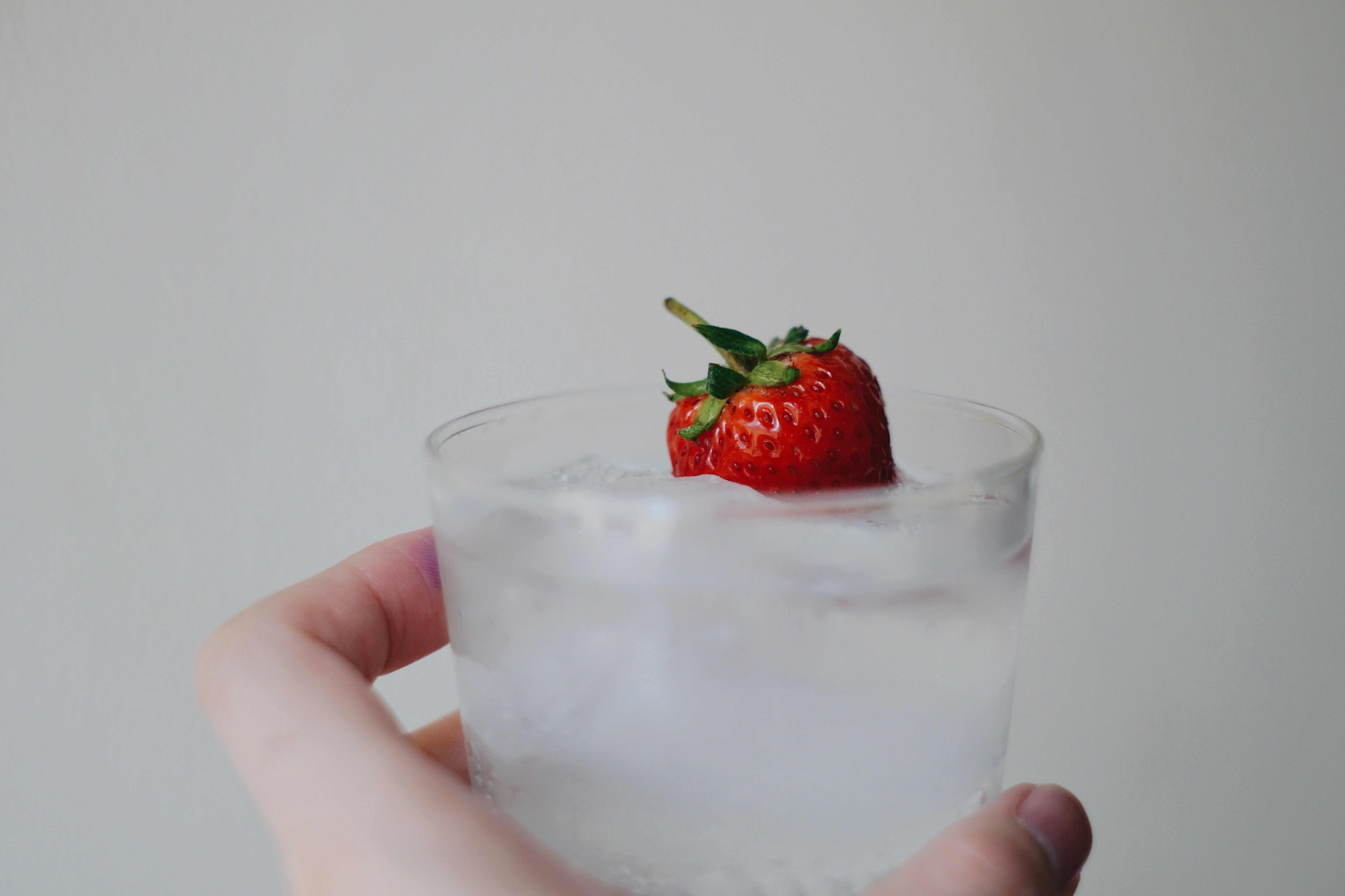 strawberry in clear drinking glass